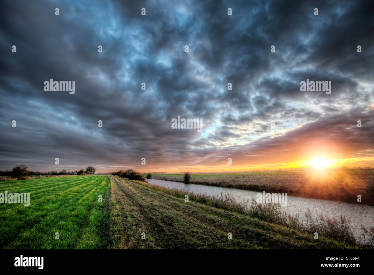 Sunrise over the Middle Level Main Drain, part of a man-made series of ...