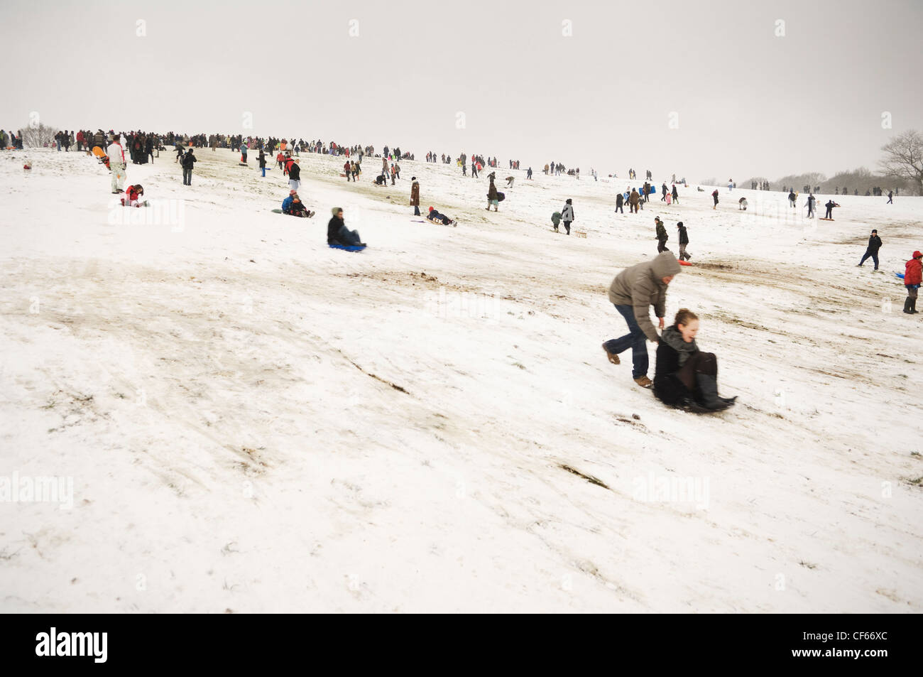 People enjoying the extreme winter conditions by sledging down Highgate ...
