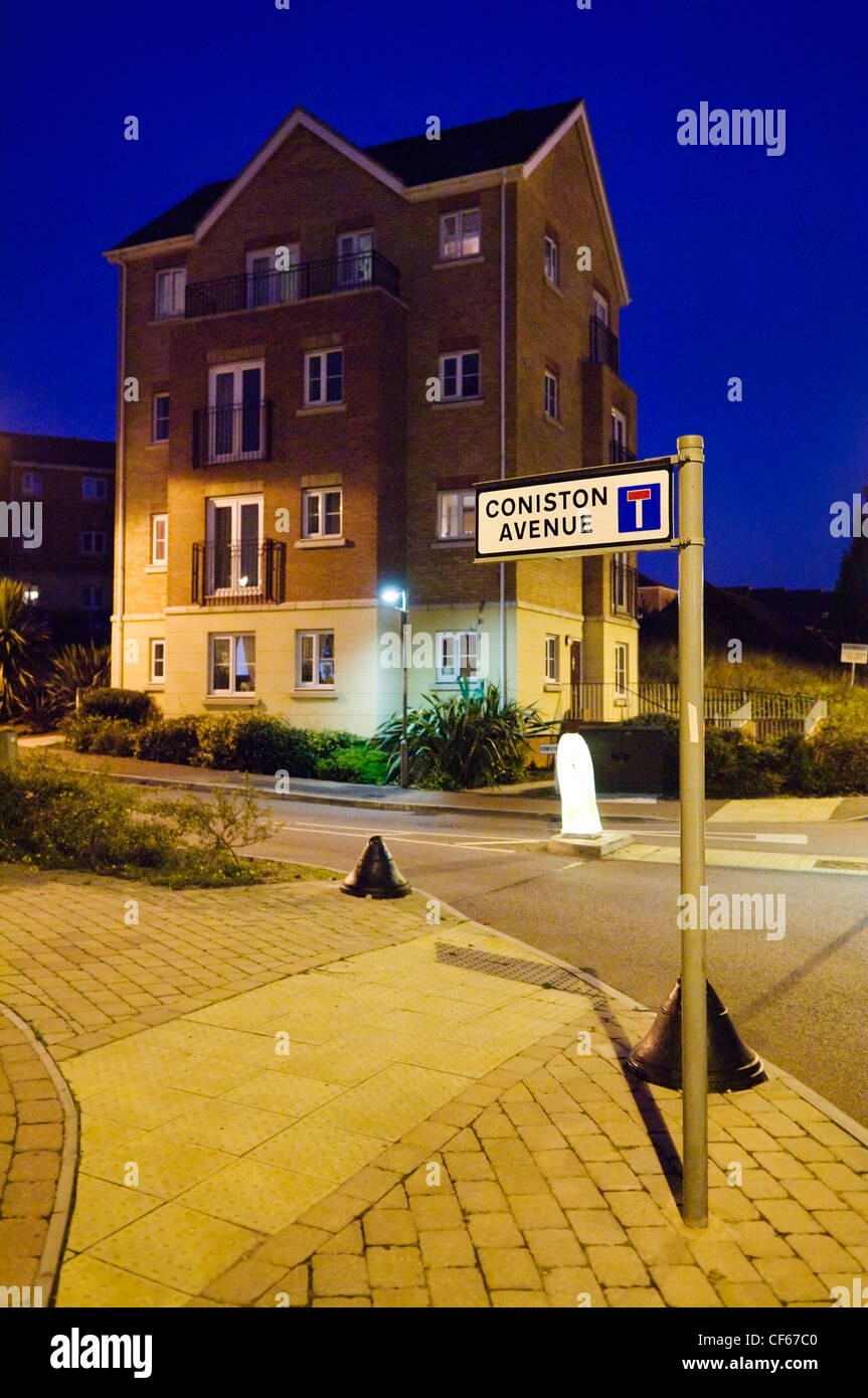 A road sign lit by a street lamp on a newly built housing estate in ...