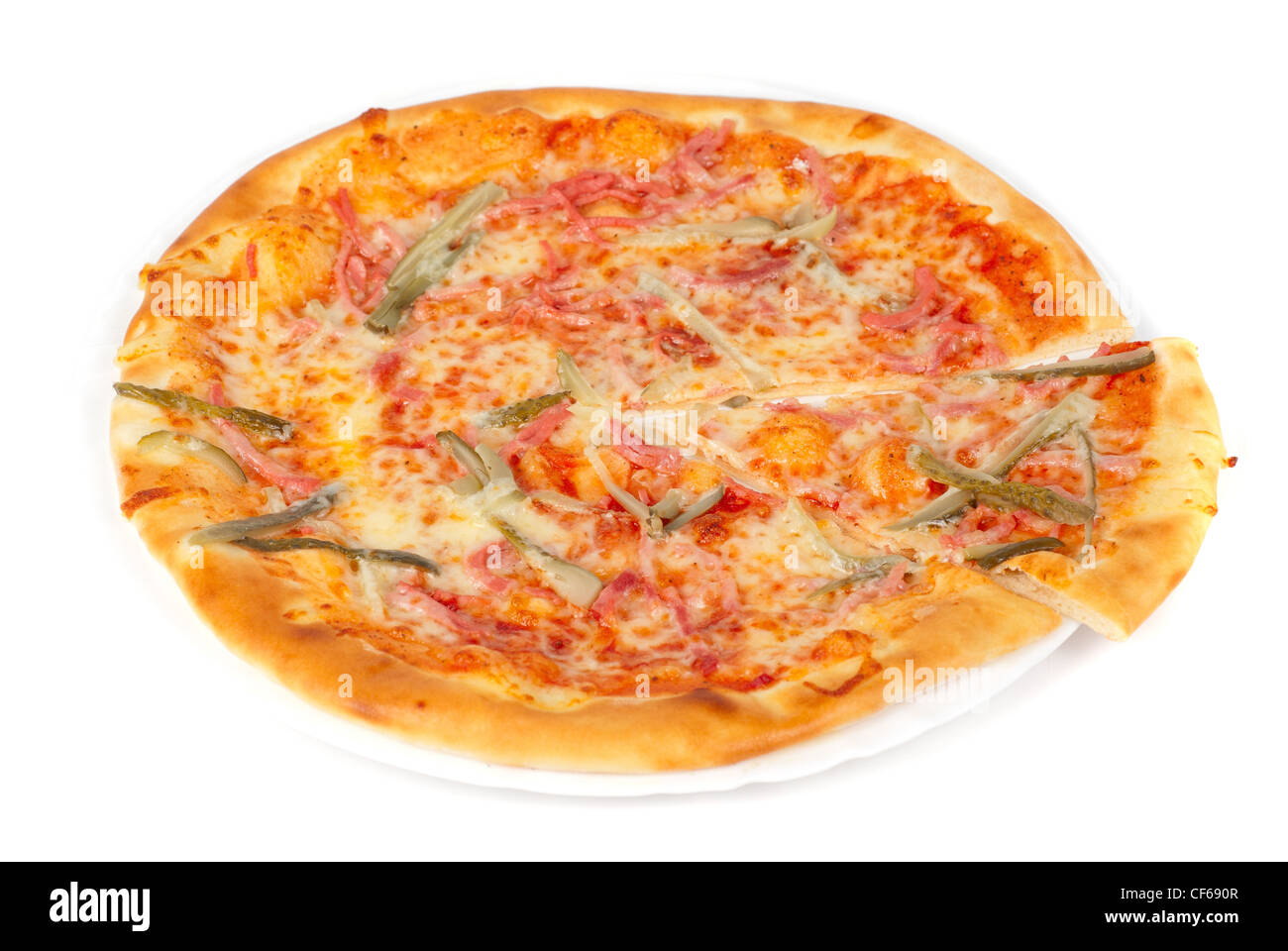 pizza closeup with boiled sausage, ham, marinated gherkin and ...