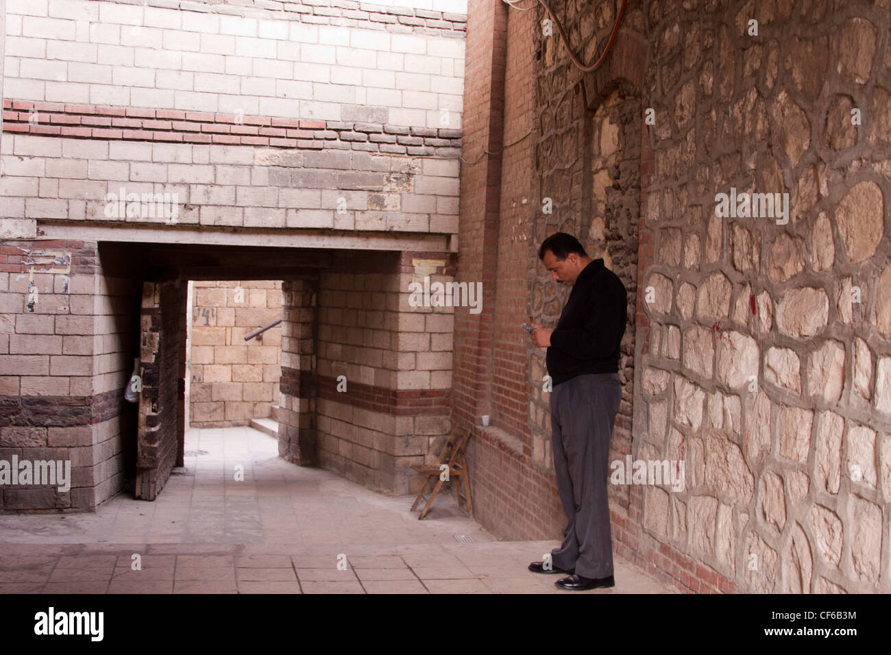 Man using his mobile in Coptic Area of Cairo. The churches were located ...