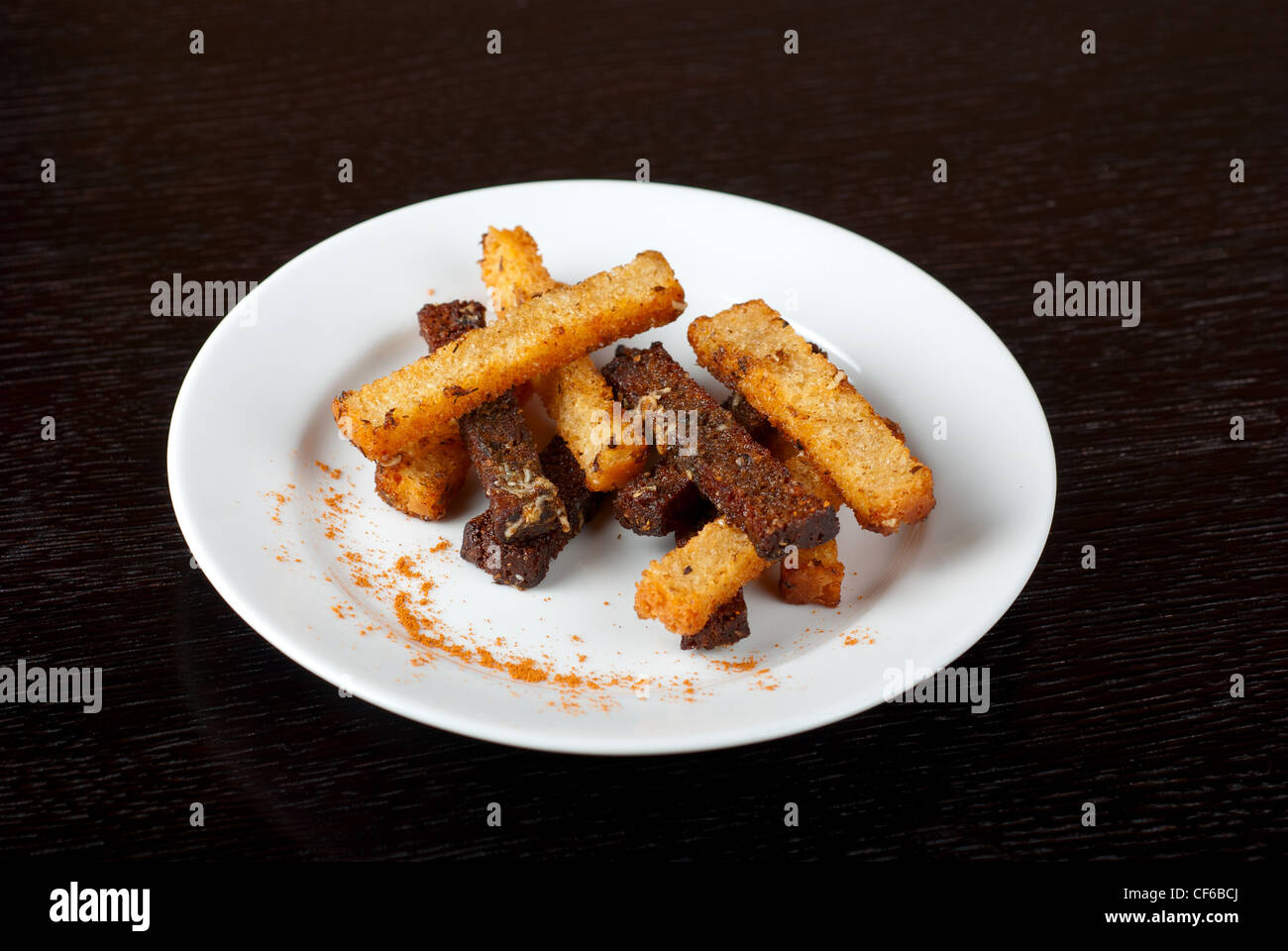 Rusk with garlic on a plate at wooden background Stock Photo - Alamy