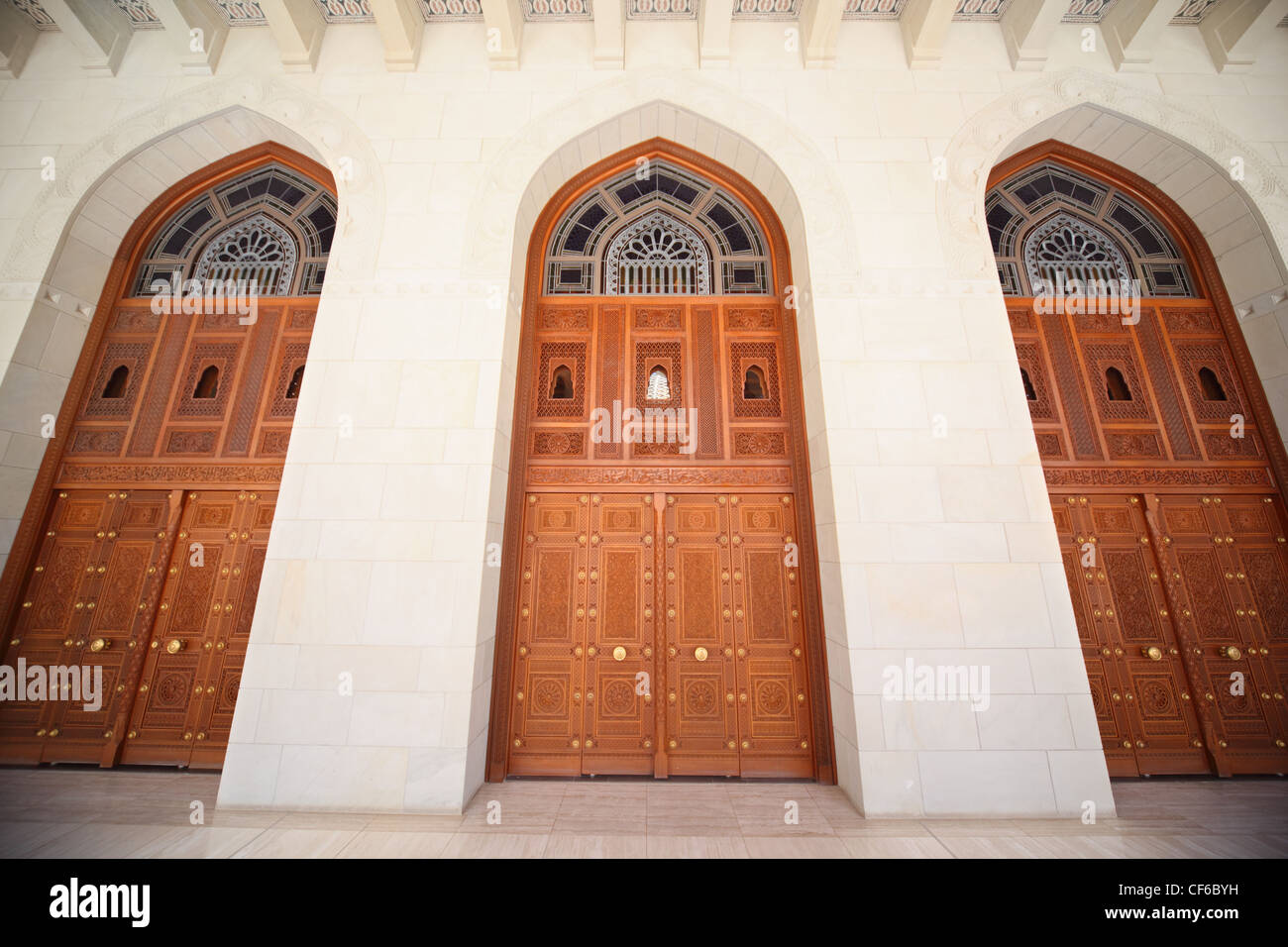 three doors of building inside Grand Mosque in Oman. wide angle Stock ...