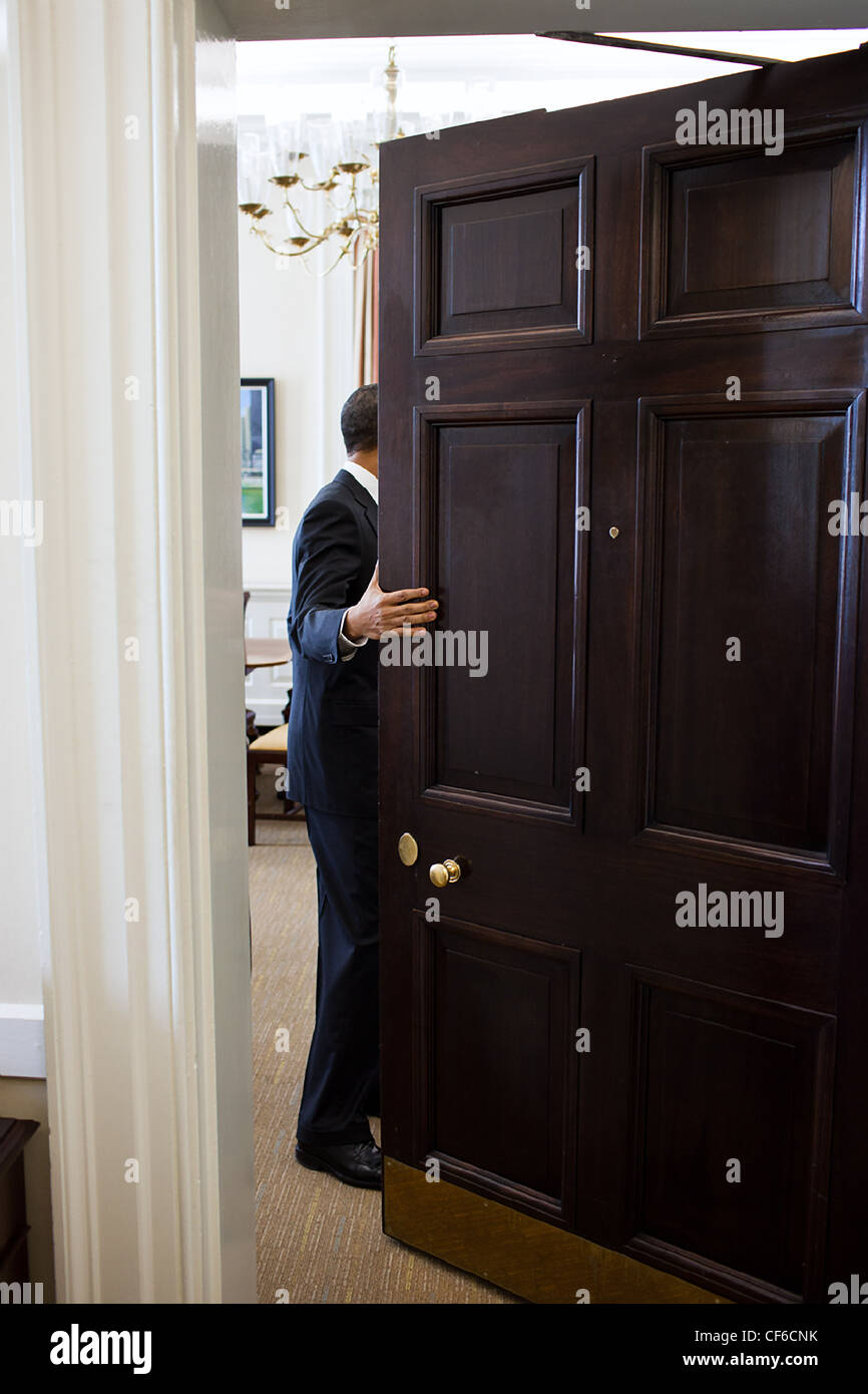 President Barack Obama holds the door while talking to Chief of Staff ...