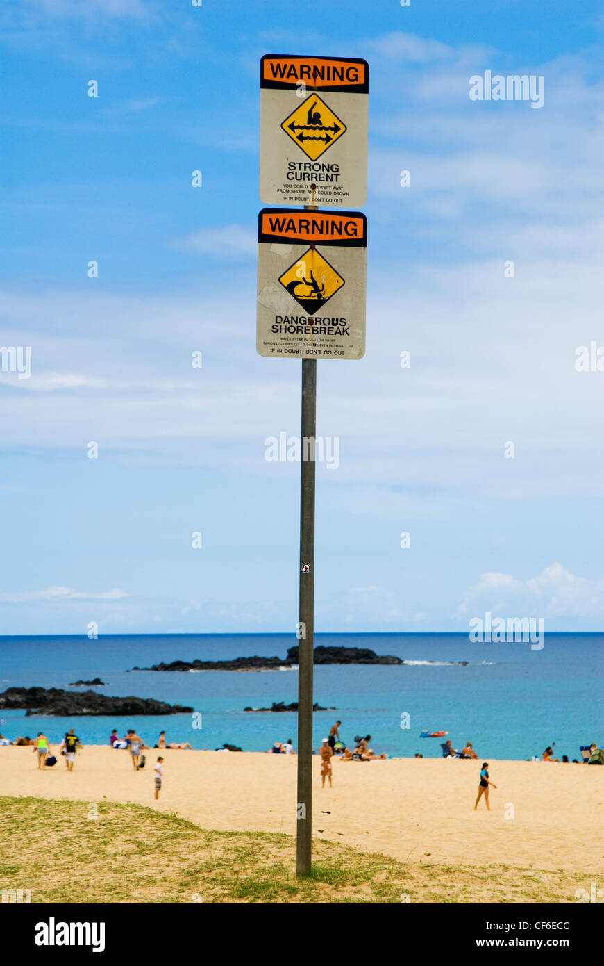 Warning sign on beach about dangerous currents and shore break waves ...
