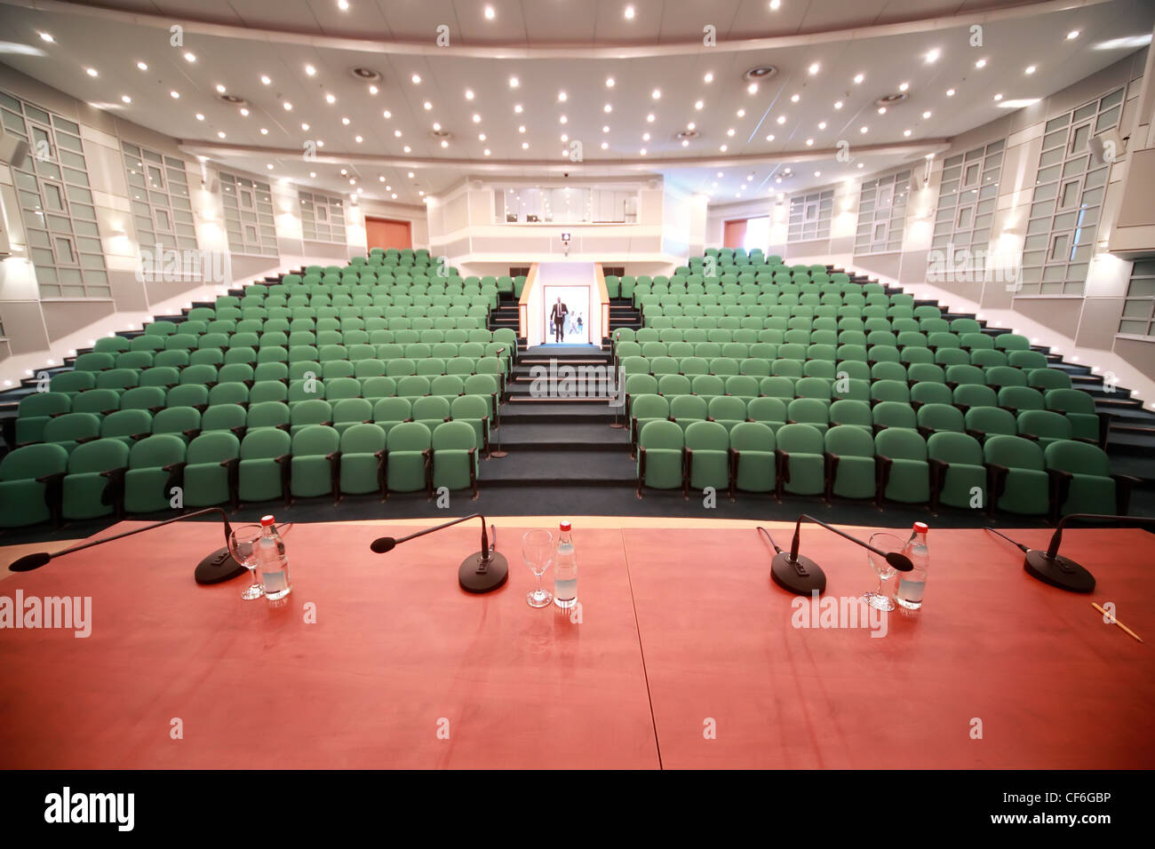 Man comes through front entrance into conference room. View from scene ...