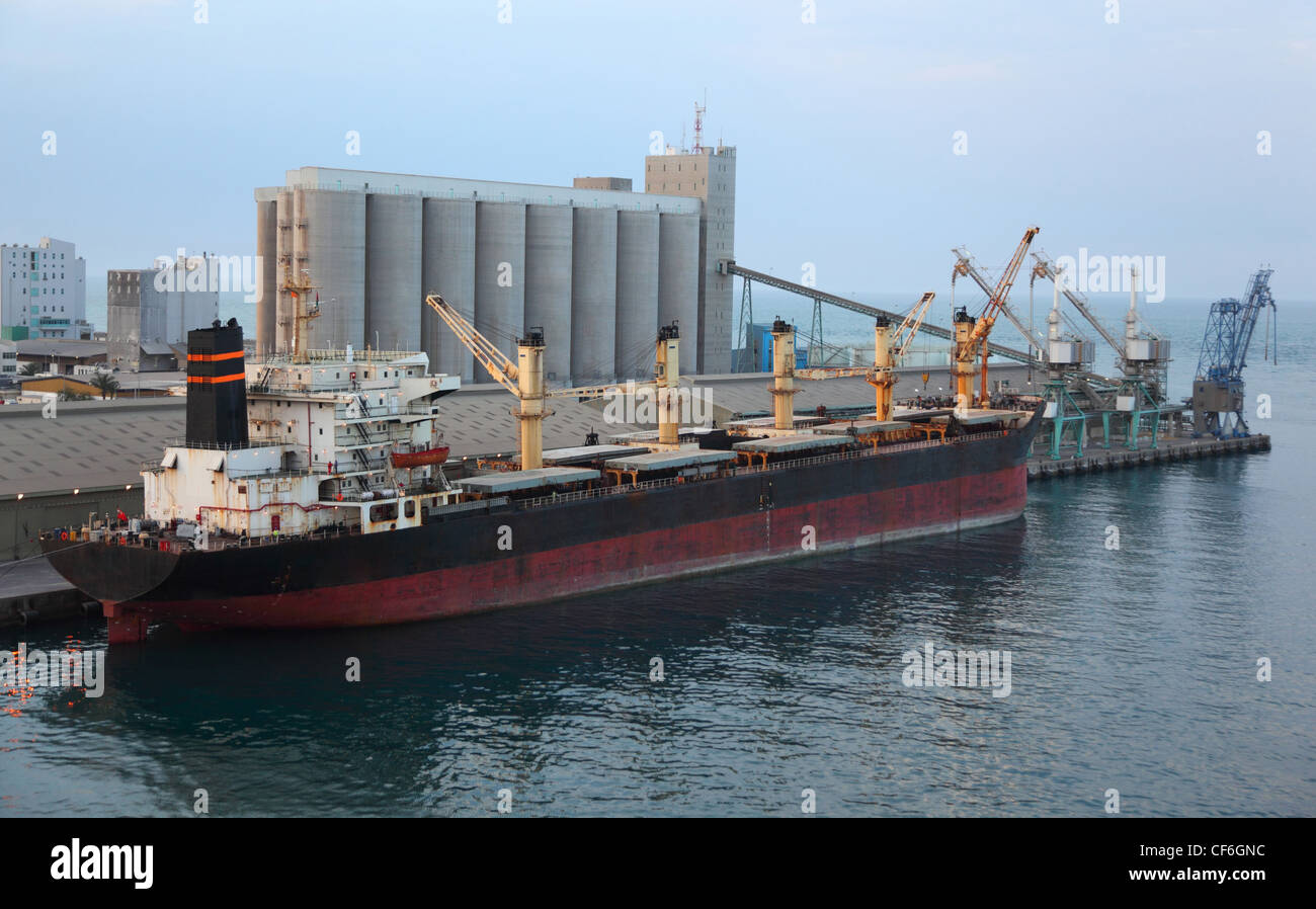 Big cargo ship docked to industrial port at evening in Abu Dhabi Stock ...
