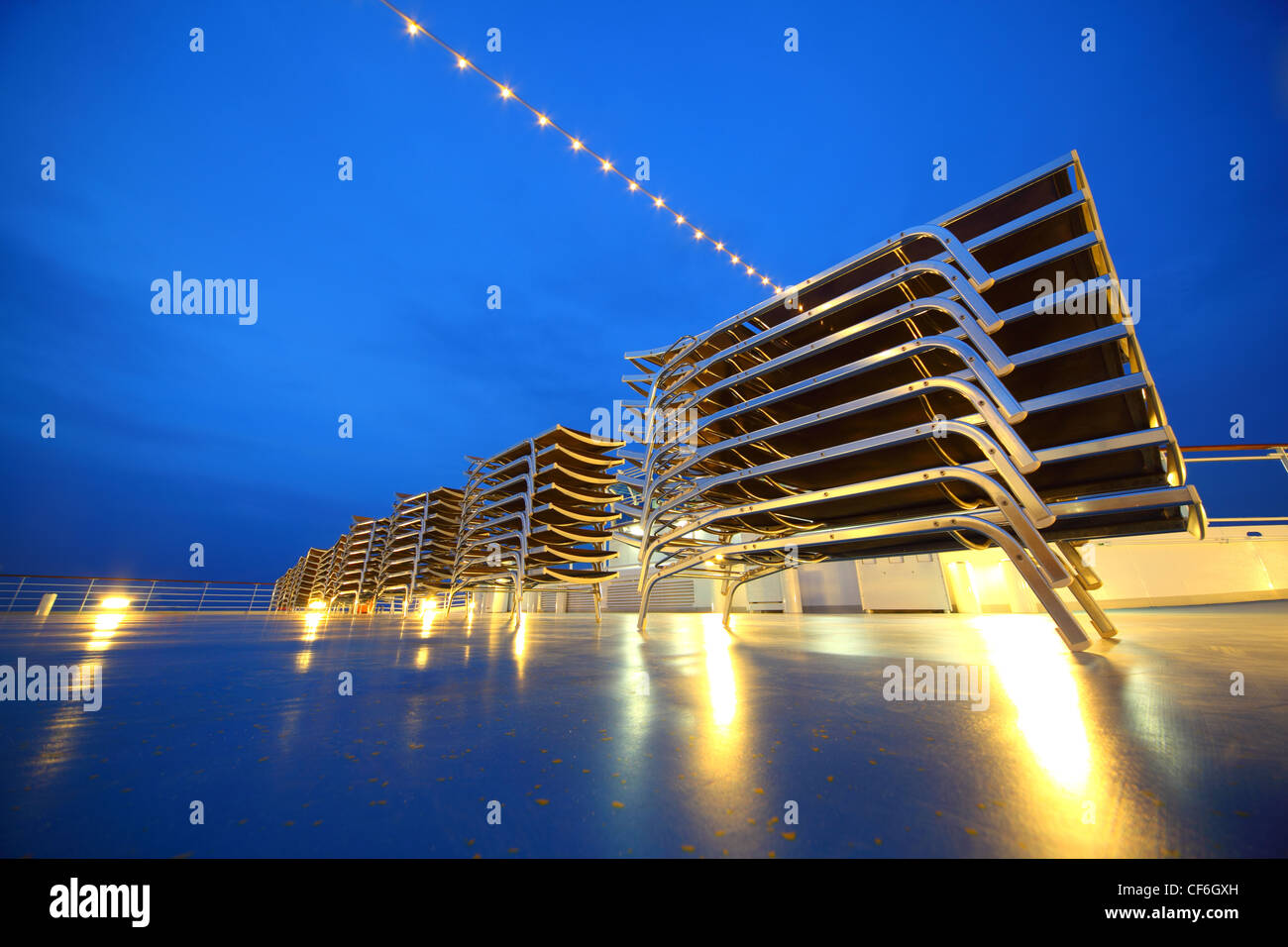 Set of illuminated deck-chair stack on ship deck in the evening Stock ...