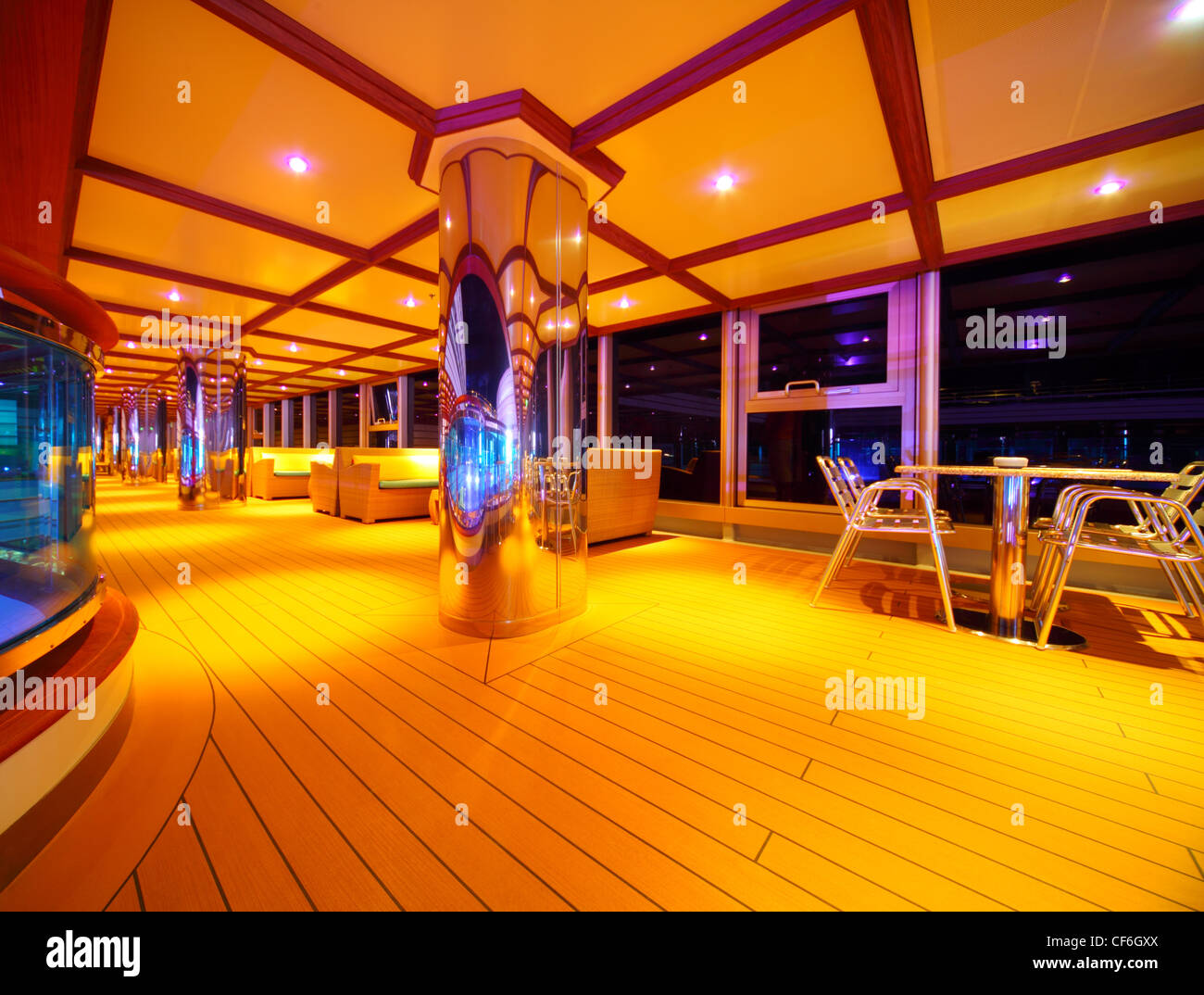 Interior of illuminated restaurant on the cruise ship deck at night ...