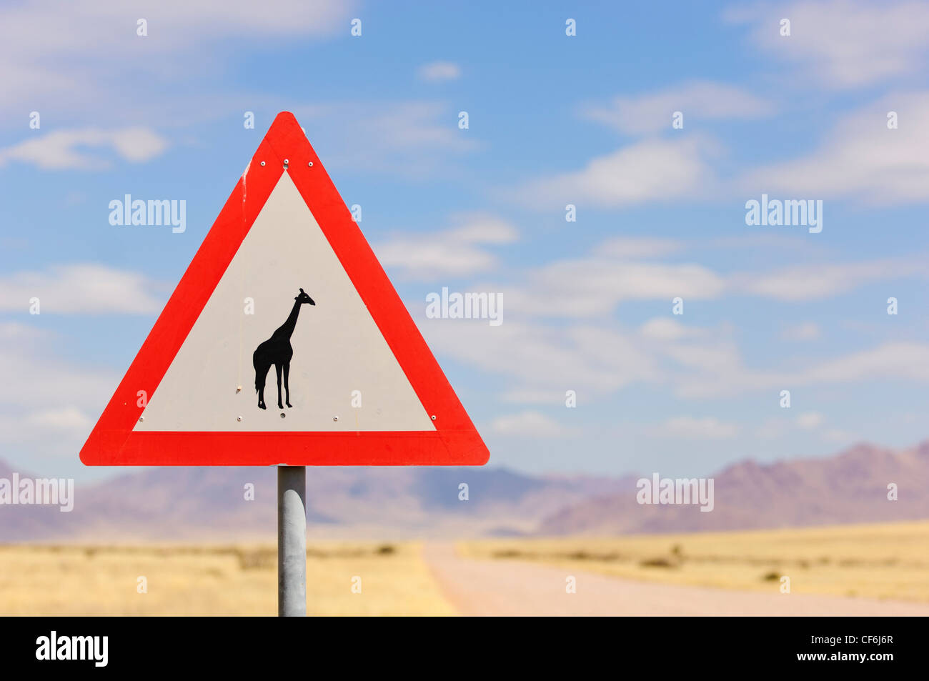 Giraffe crossing sign along a gravel road. Namibia Stock Photo - Alamy