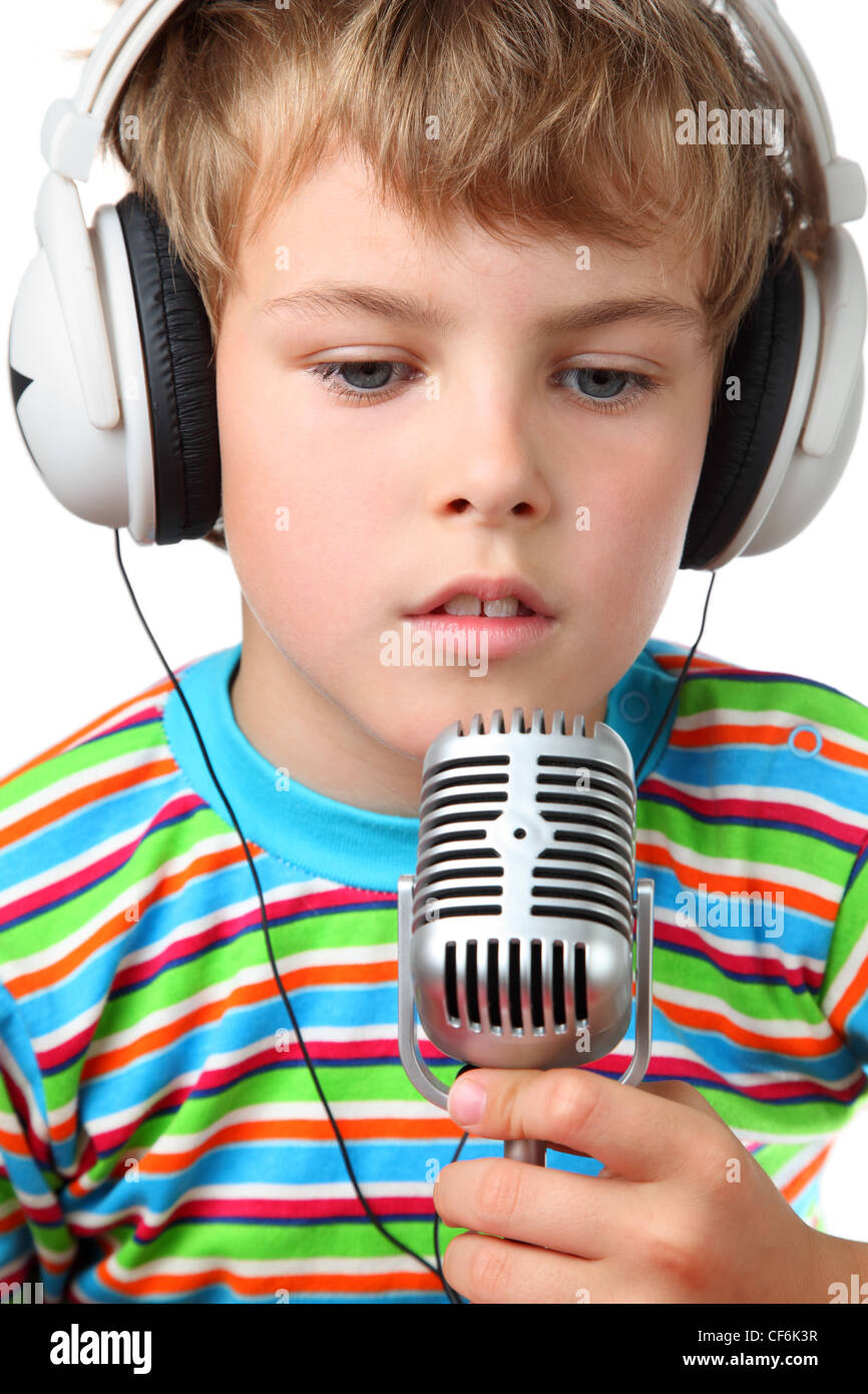 Little cheerful boy in headphone with microphone in hands opened ...