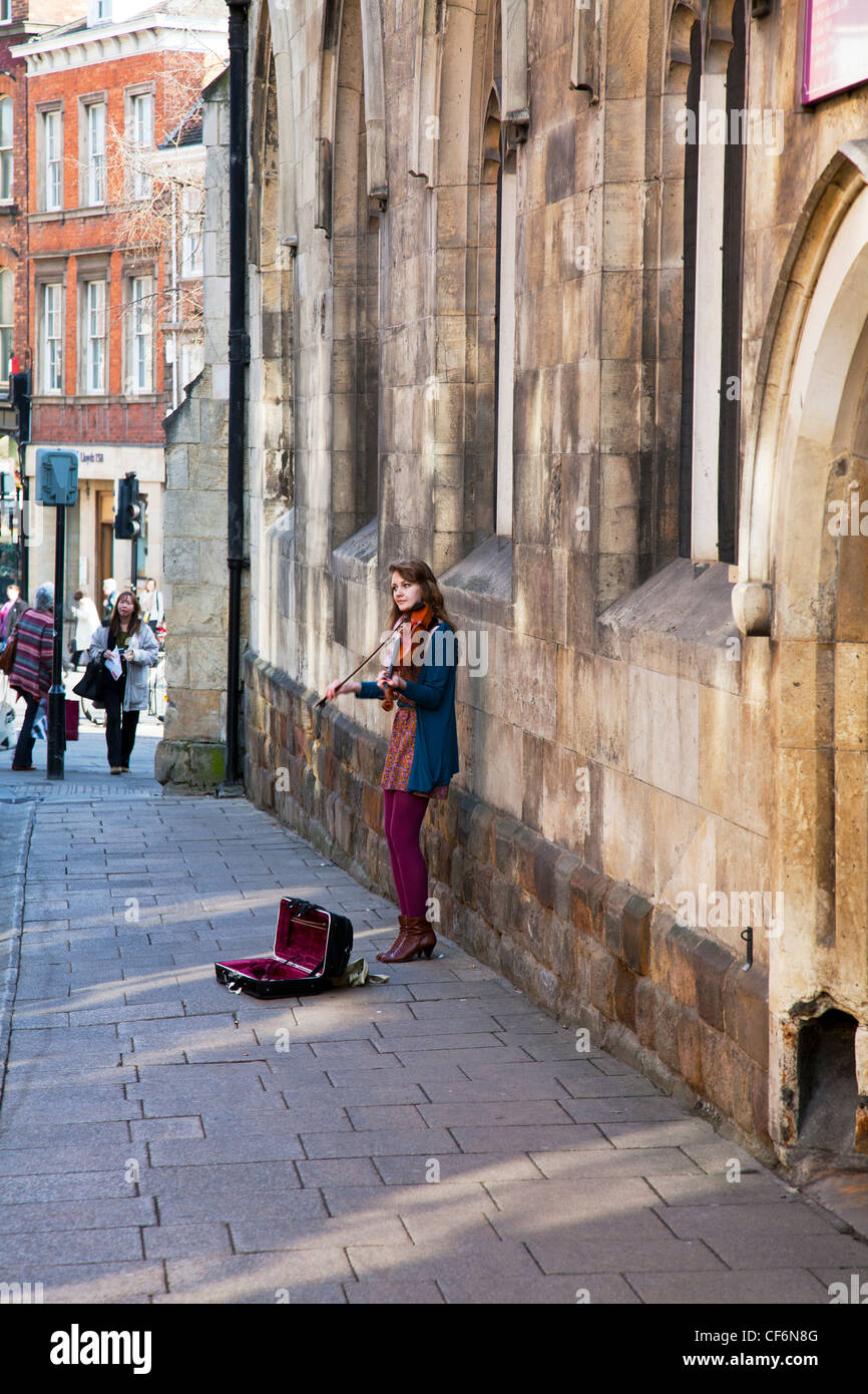 York City, Yorkshire, England young lady busking, playing violin for ...