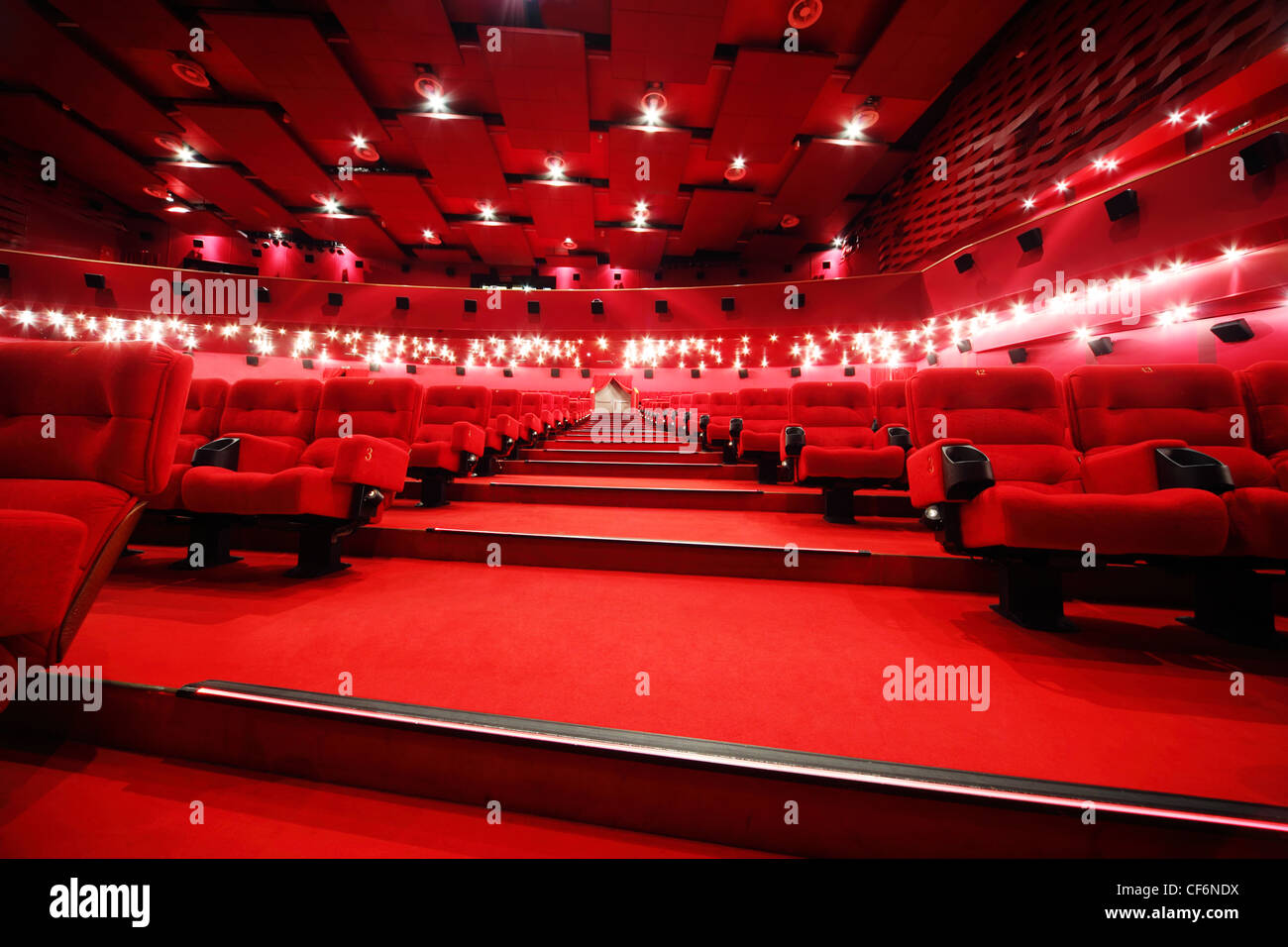 Low-angle view of stairs between rows of comfortable red chairs in ...