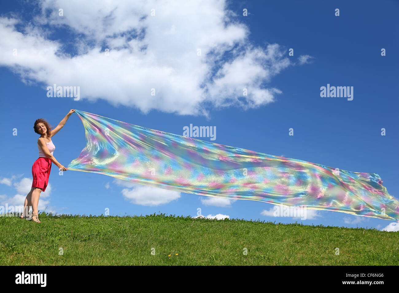 Woman holds hands long fabric which develops on wind Stock Photo - Alamy