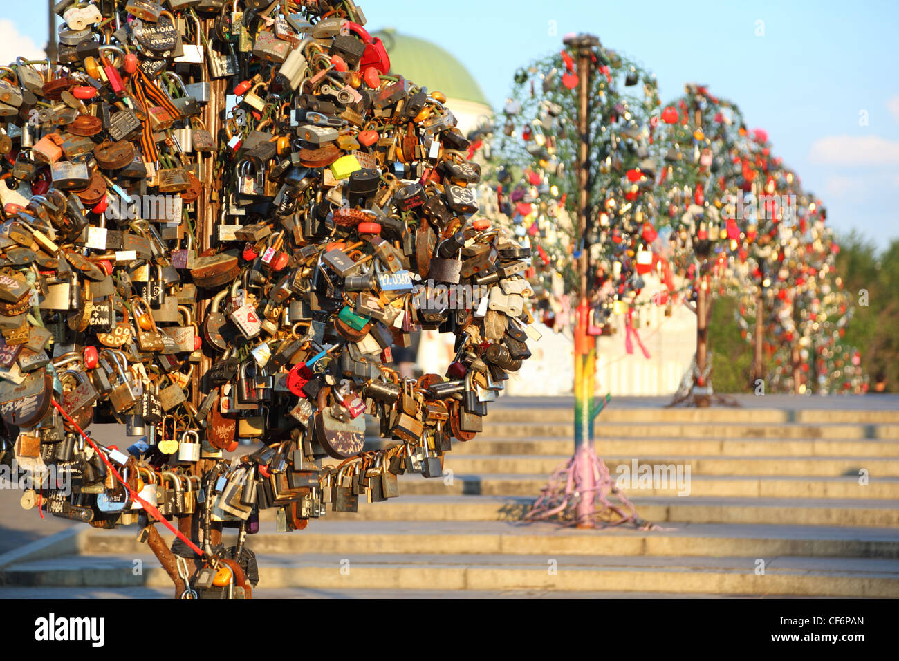 Trees from metal, symbolic given light weight padlock Stock Photo - Alamy