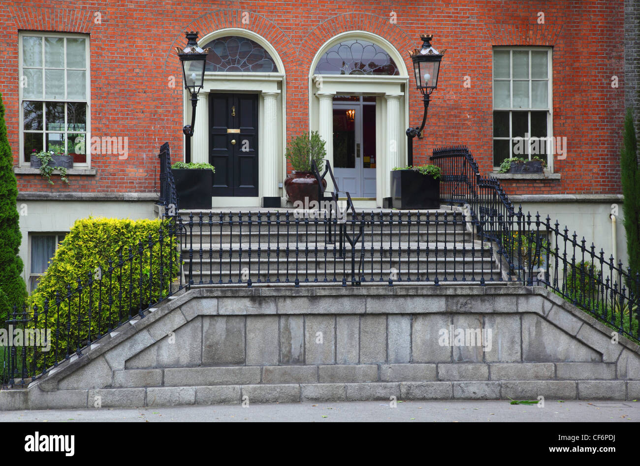 first floor and the entrance to a beautiful building of red brick Stock ...