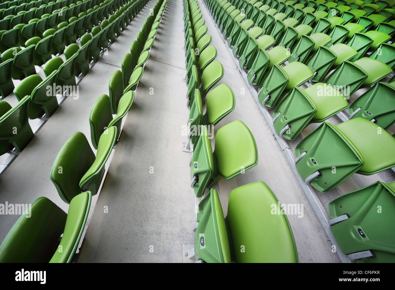 Rows of folded, green, plastic seats in very big, empty stadium Stock ...