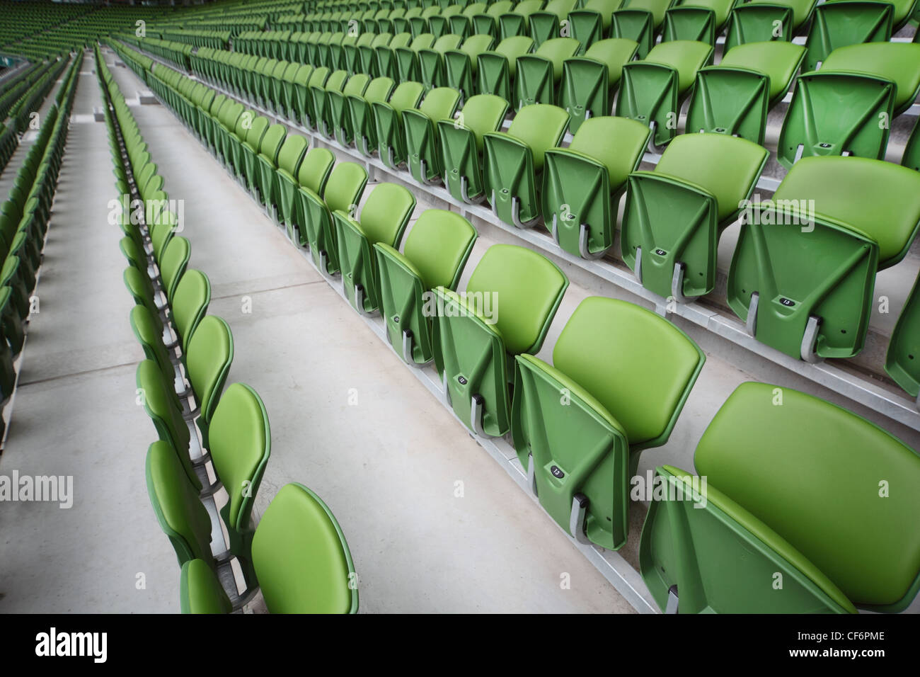 Rows of folded, green, plastic seats in very big, empty stadium Stock ...