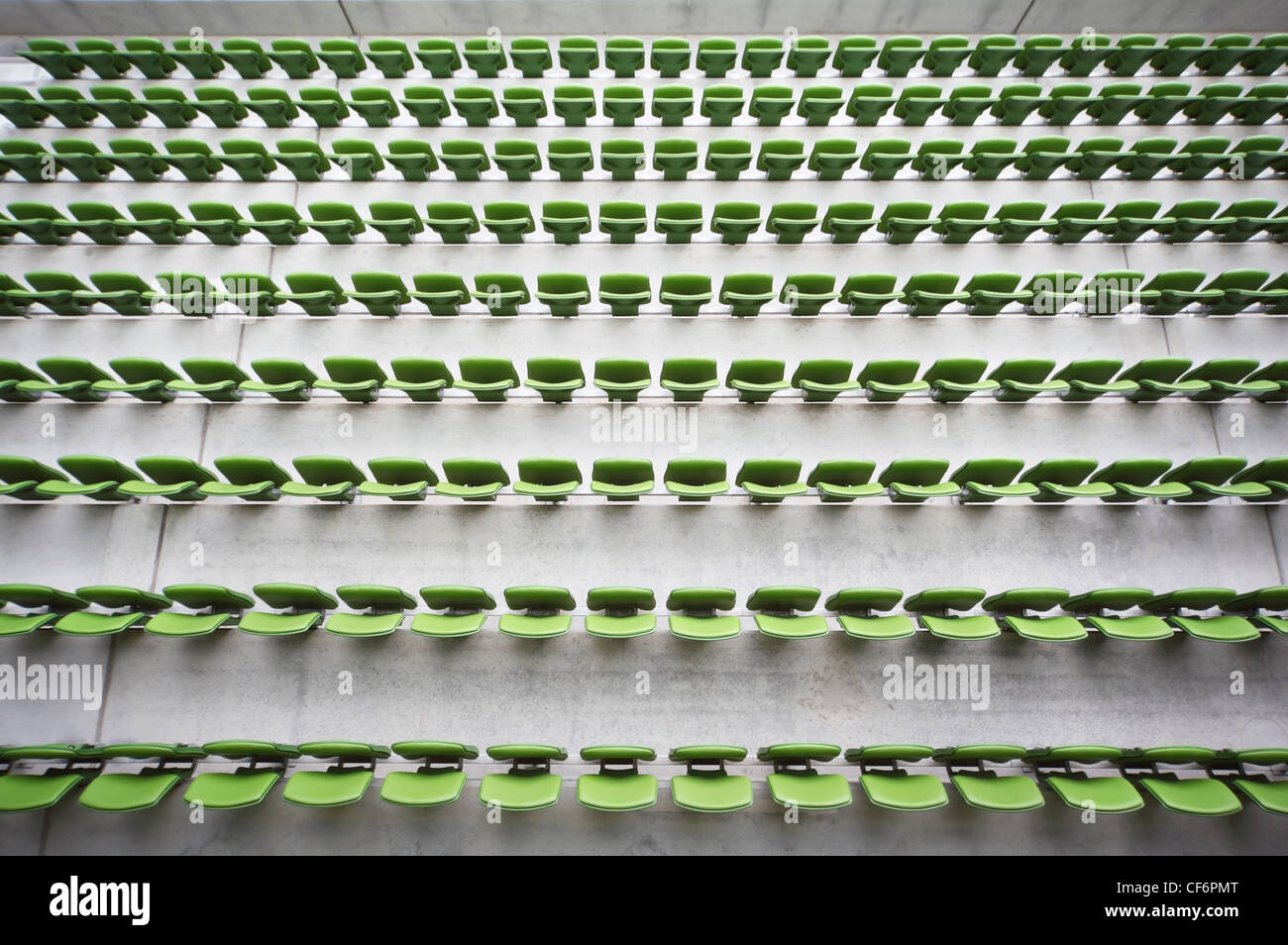 Rows of folded, green, plastic seats in very big, empty stadium Stock ...