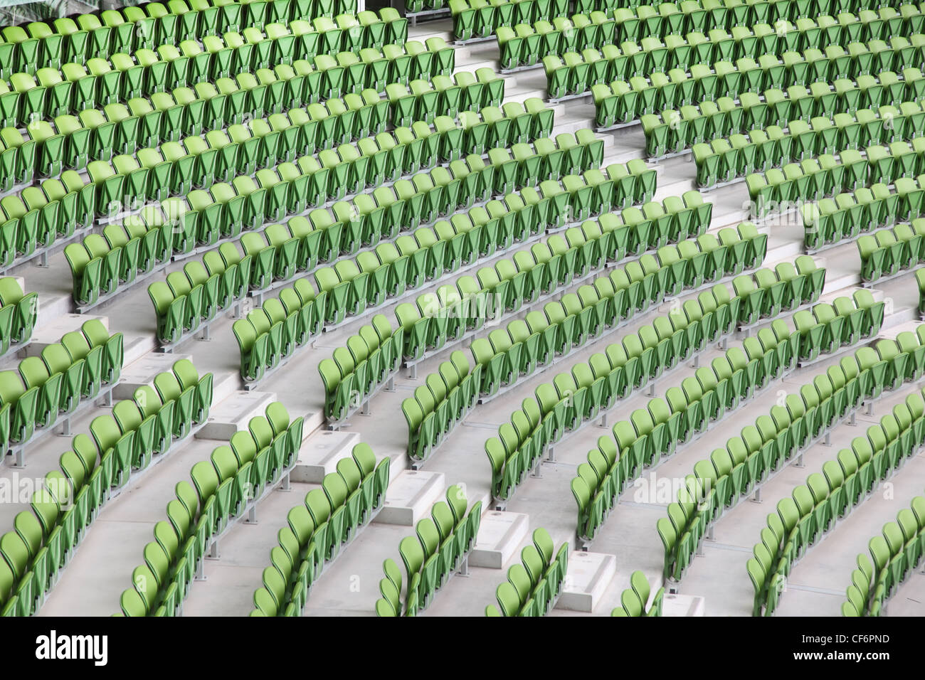 Rows of folded, green, plastic seats in very big, empty stadium Stock ...