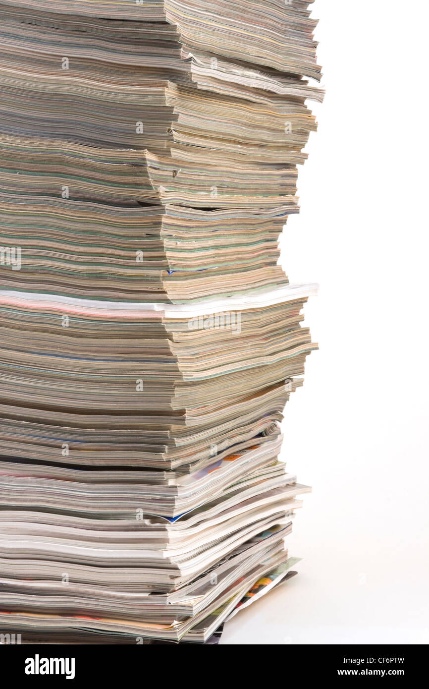 Large stack of magazines on white background Stock Photo - Alamy