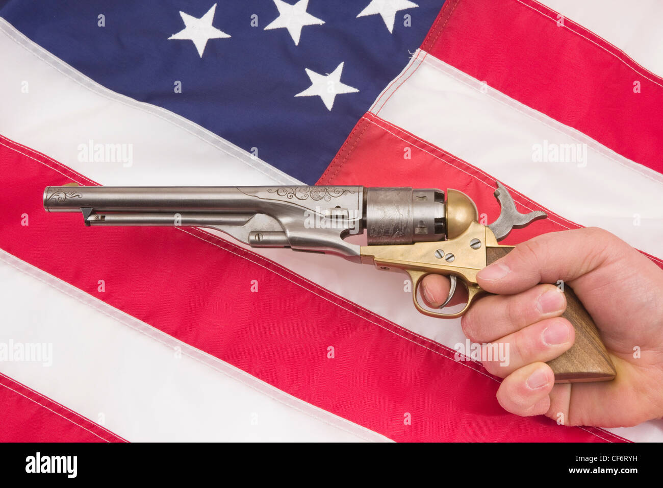Human hand shooting antique pistol over American Flag background Stock ...