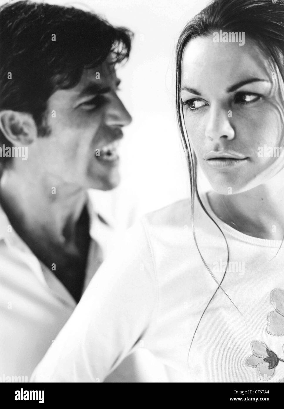 Couple arguing female standing with back to male shouting aggressive ...