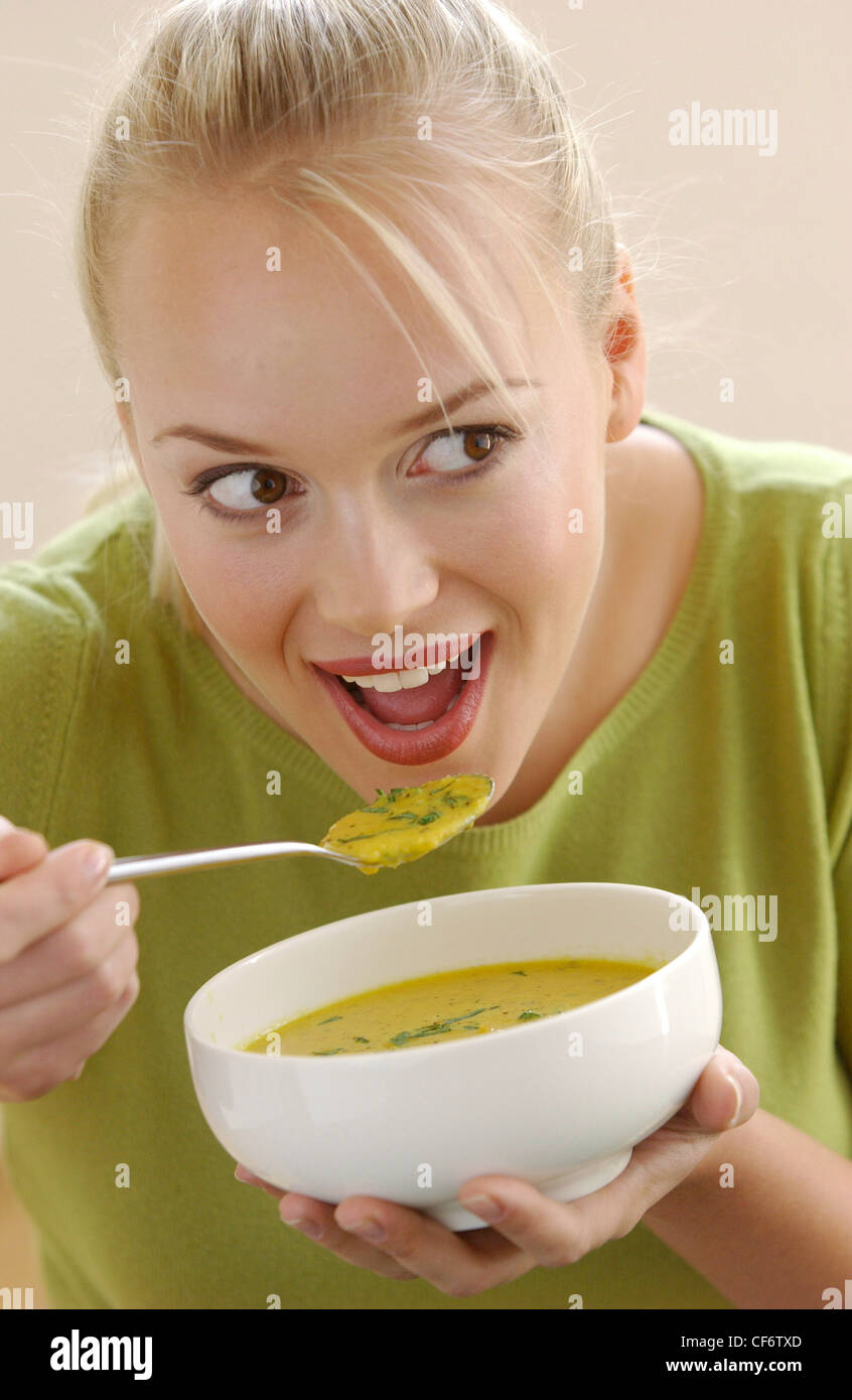 Female blonde hair up strands of fringe over forehead wearing olive ...