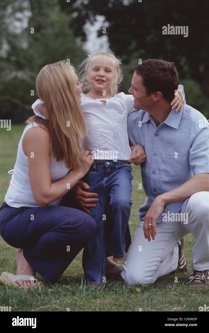Mother long straight blonde hair father short brown hair kneeling ...