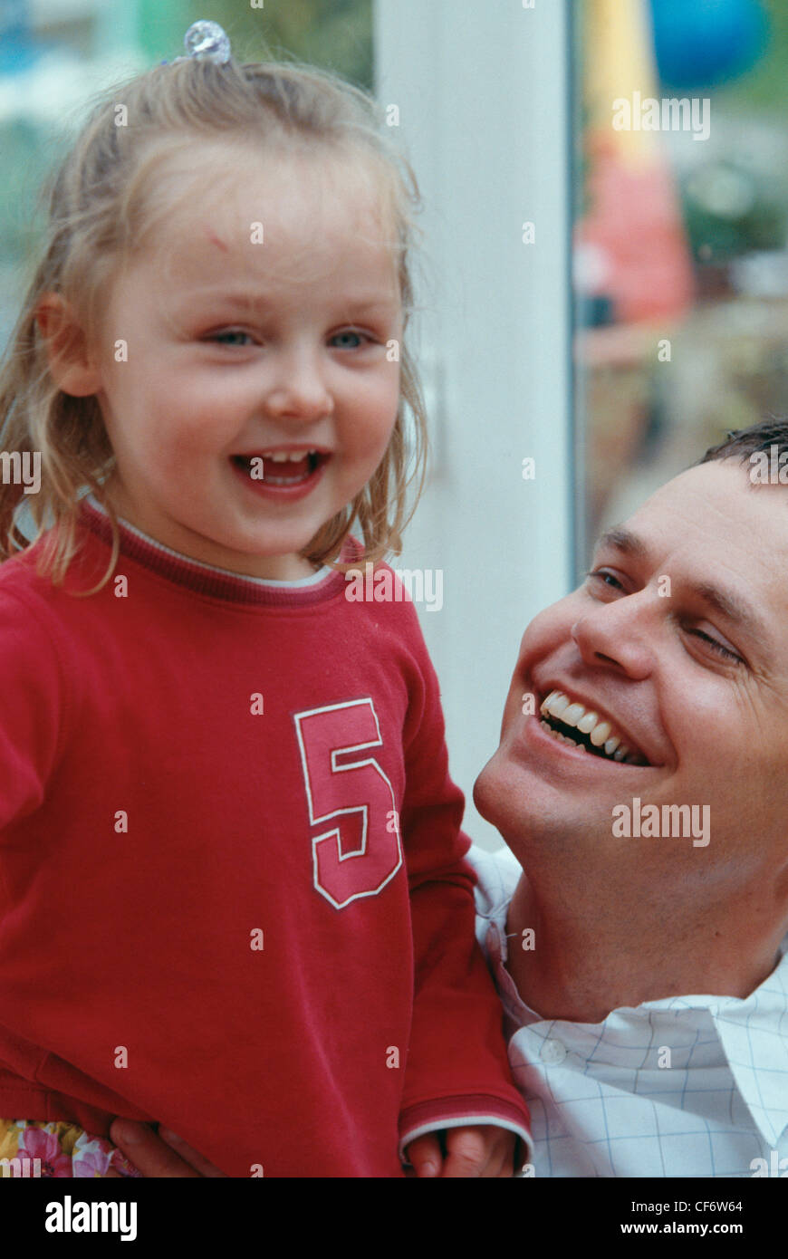 Father with short brown hair looking up at female child blonde hair ...