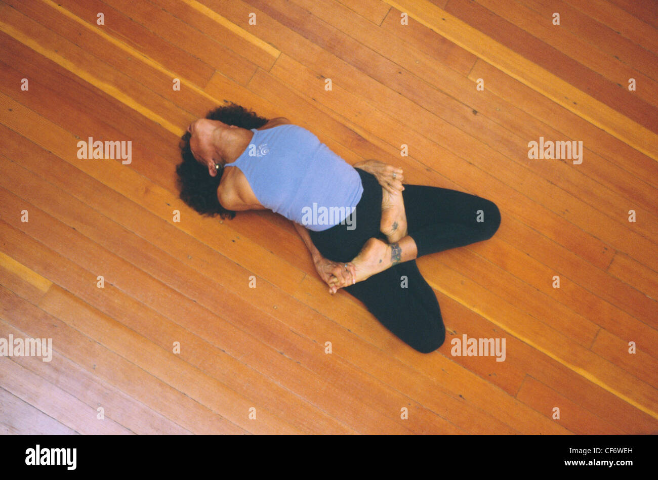 Aerial view of female lying on back arms crossed under back holding ...