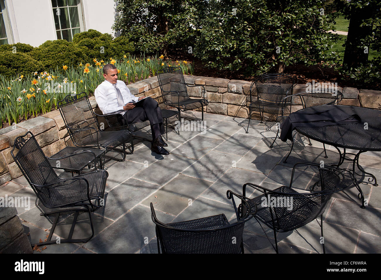 President Barack Obama sits alone on the patio outside the Oval Office ...