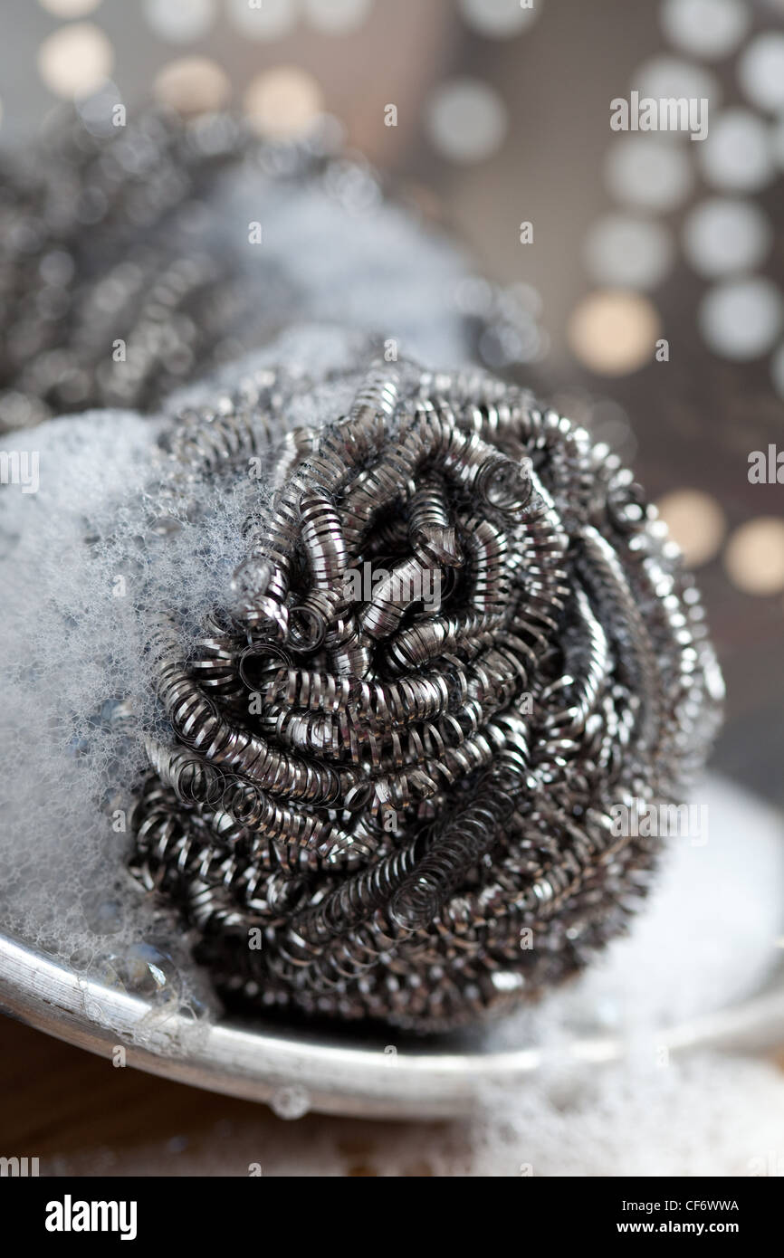 Wire abrasive pan scourer in a colander with washing up lather Stock ...