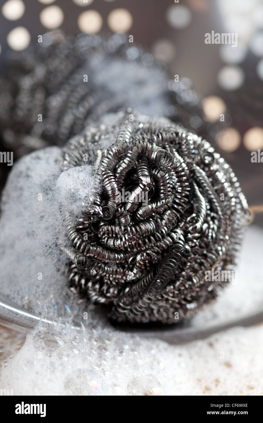 Wire abrasive pan scourer in a colander with washing up lather Stock ...