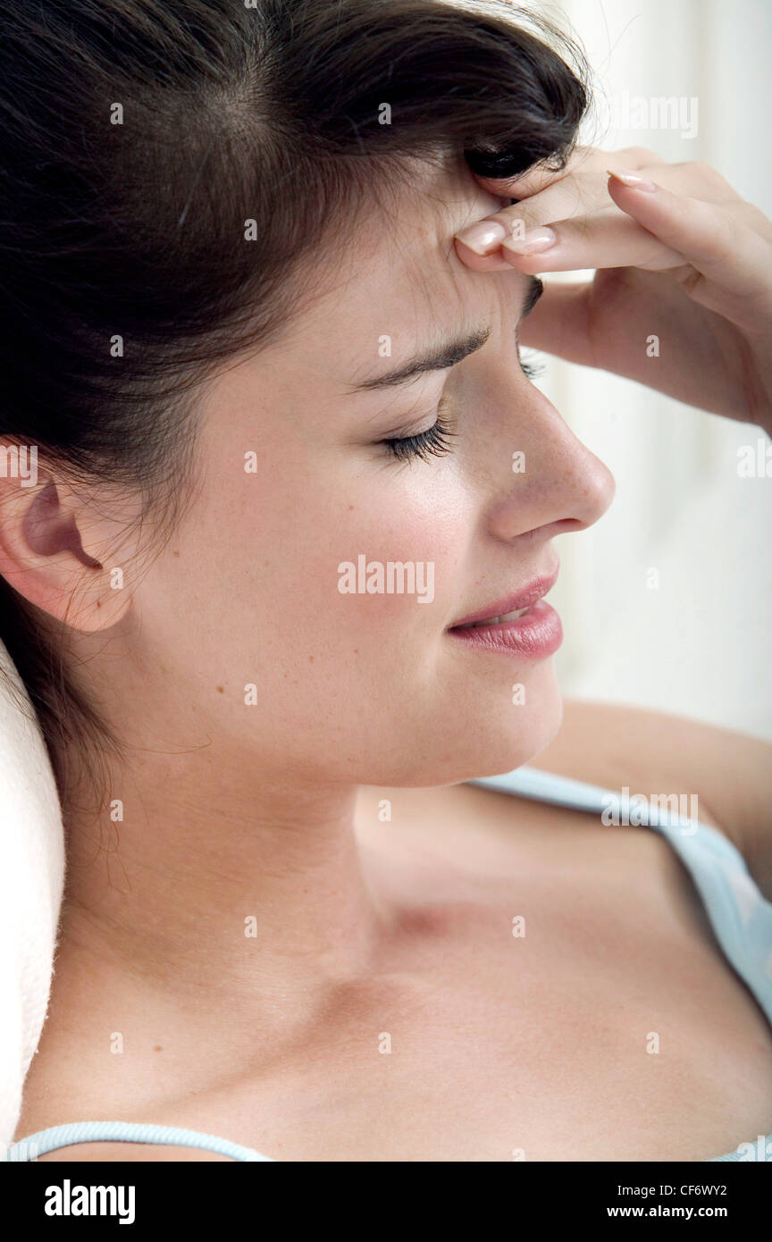 Female brunette hair off face wearing blue and white striped vest top ...