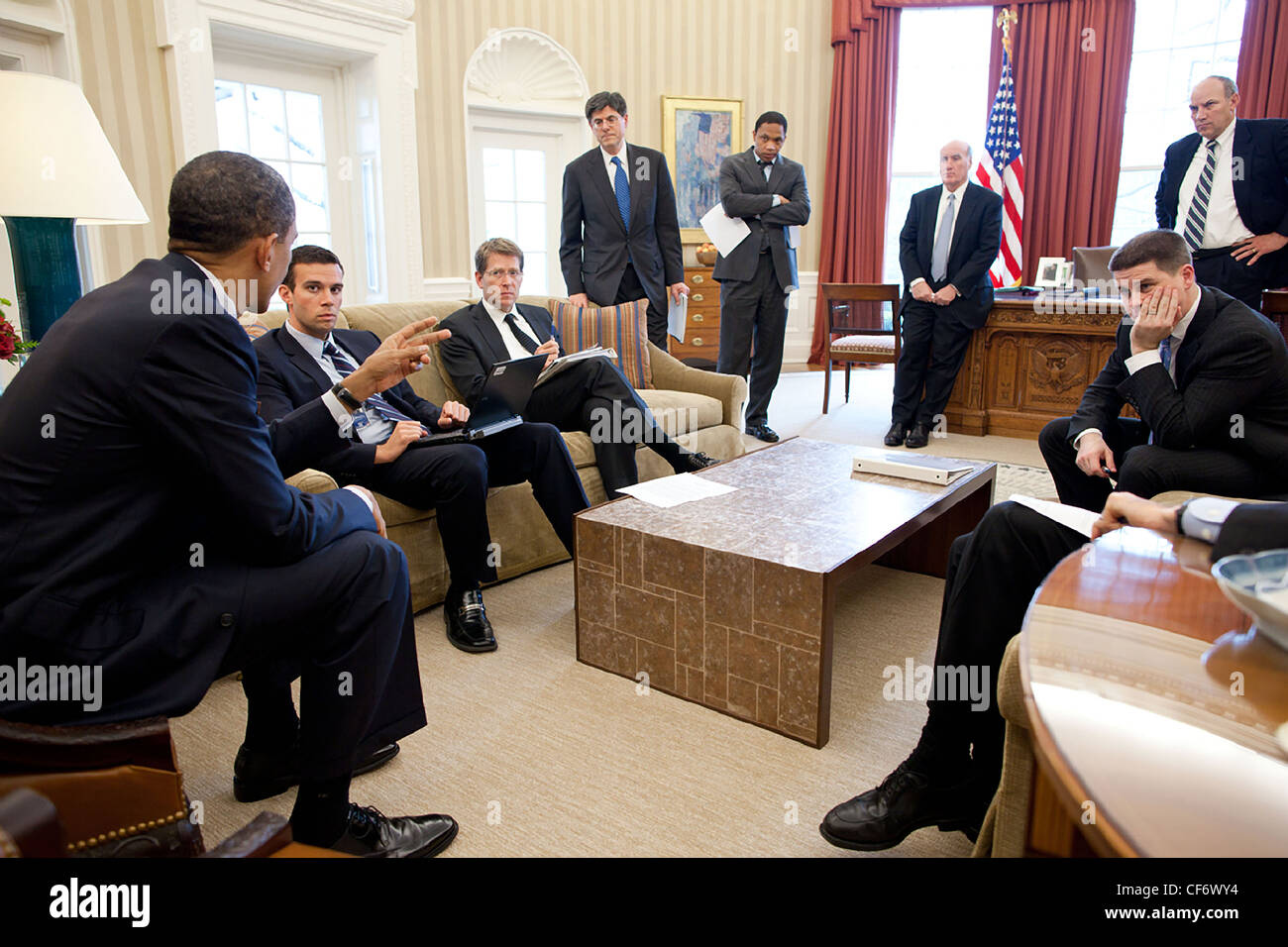 President Barack Obama meets with staff in the Oval Office before a ...