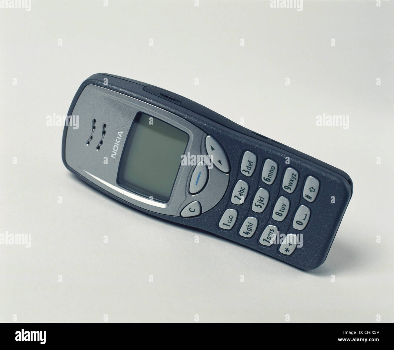 Grey and silver Nokia mobile phone on side against white background ...