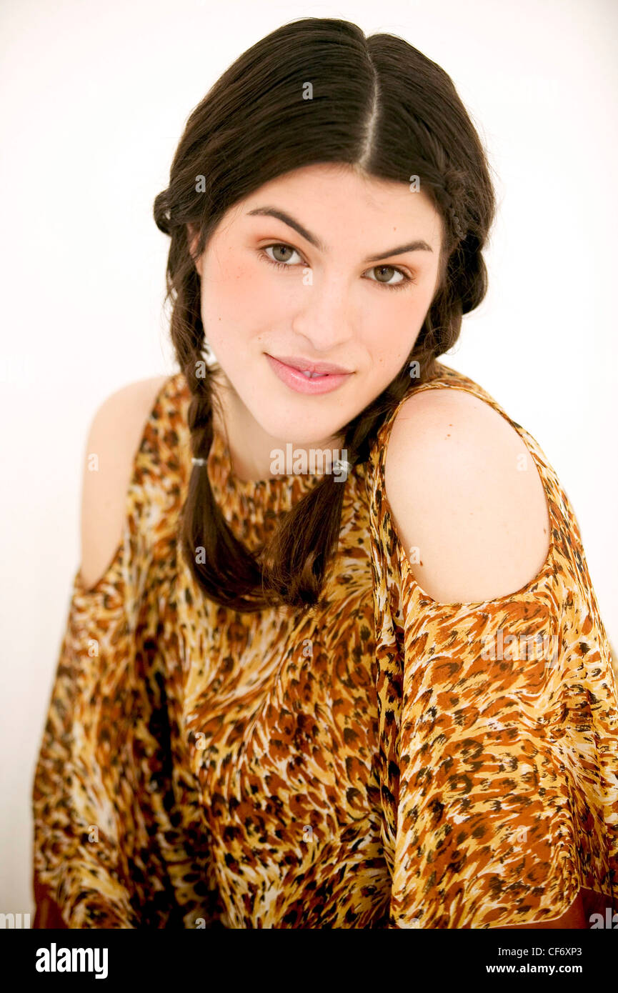 Female brunette hair in plaits, wearing brown patterned top cut outs at ...