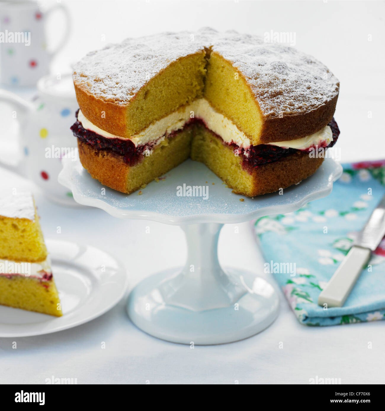 Victoria sponge cake slice cut out on white cake stand, white ...