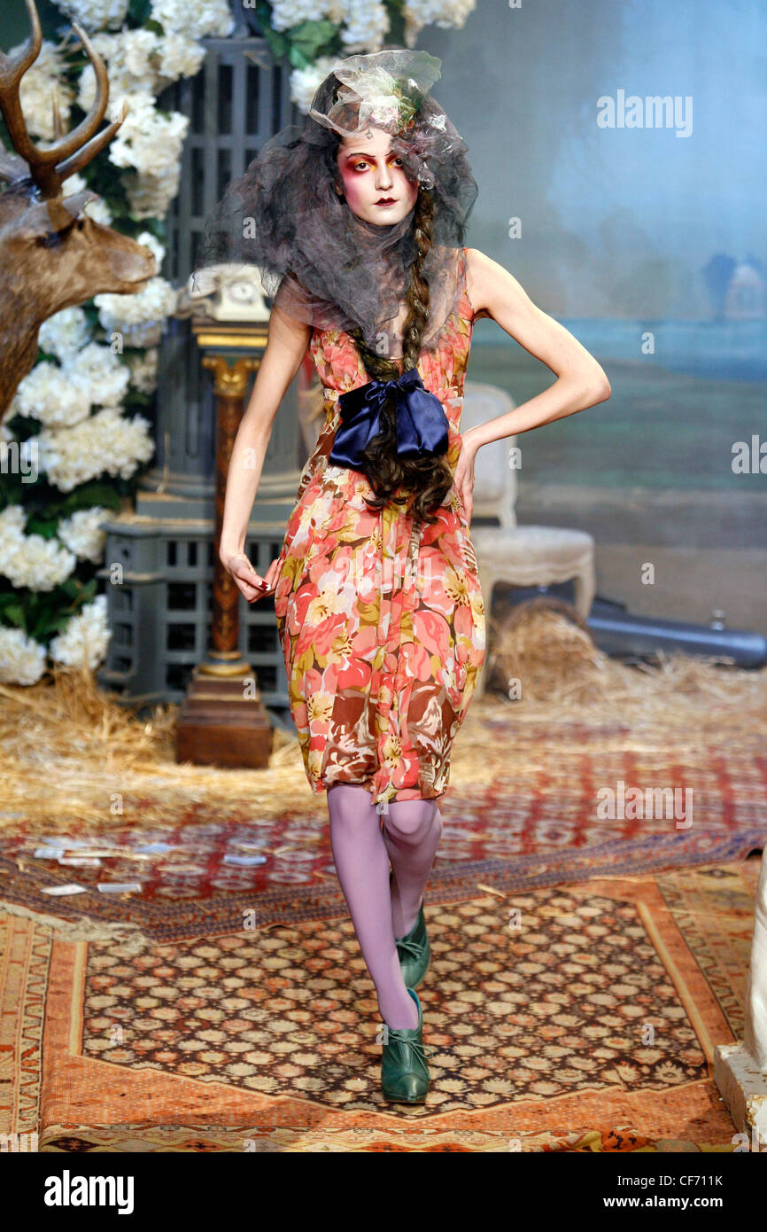 John Galliano Paris Ready to Wear Autumn Winter Model wearing pink red ...