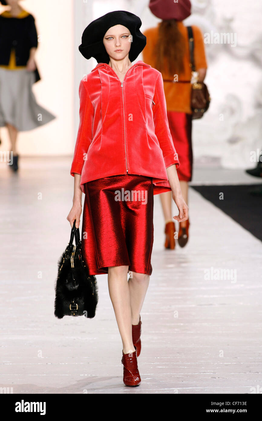 Model wearing red metallic skirt, red jacket, black beret Stock Photo ...