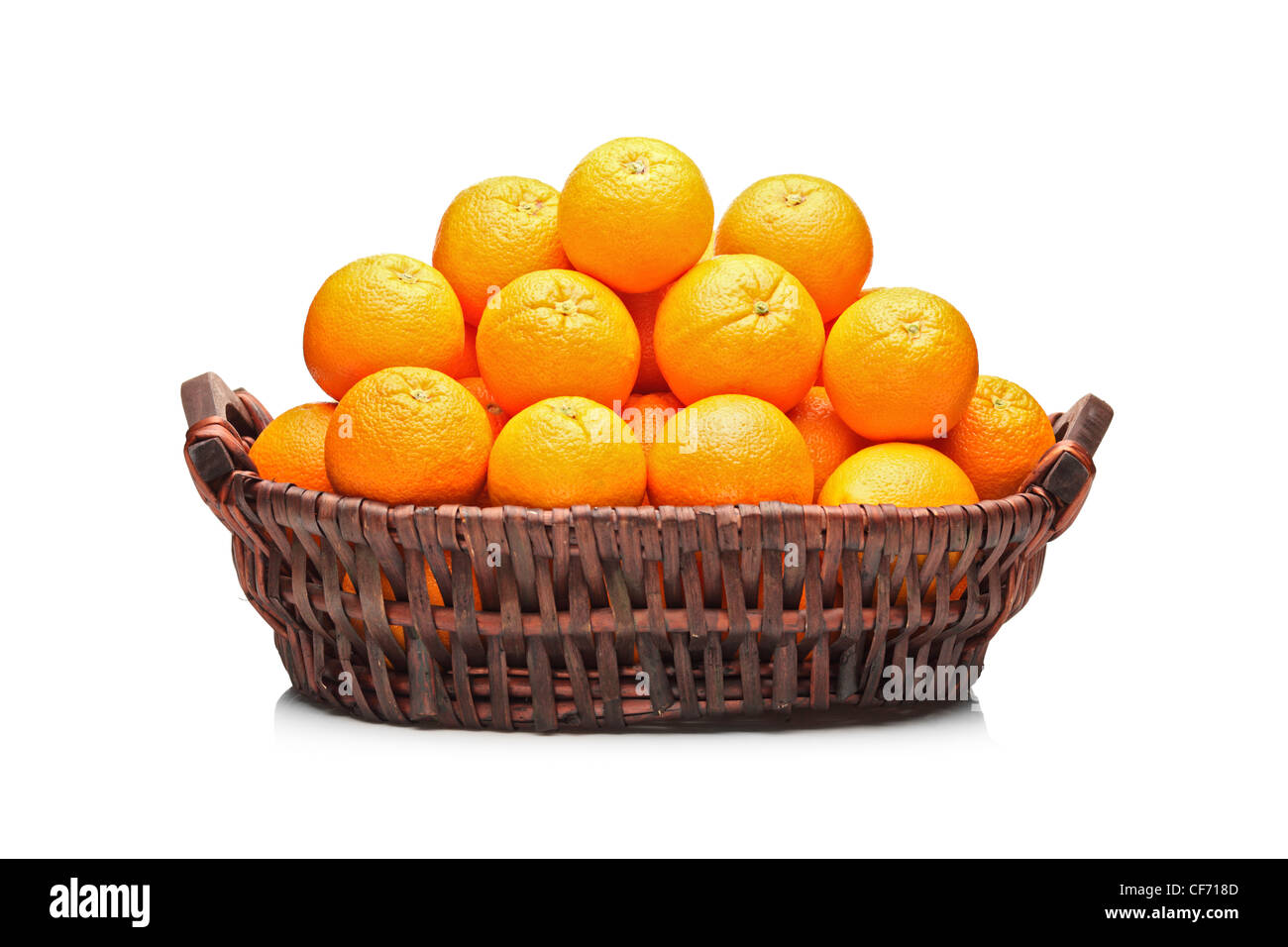 Many oranges in a basket isolated on white background Stock Photo - Alamy
