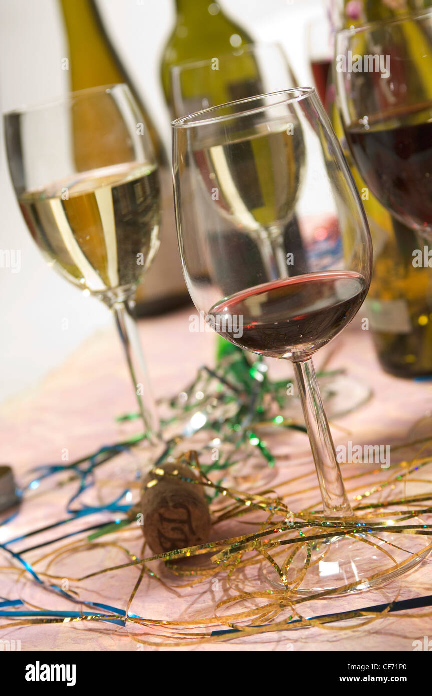 Glasses of red and white wine, cork, gold red and green streamers ...