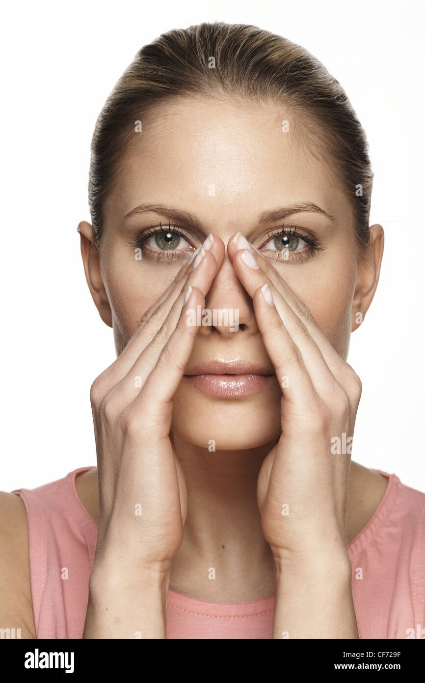 Female with hands on nose Stock Photo - Alamy