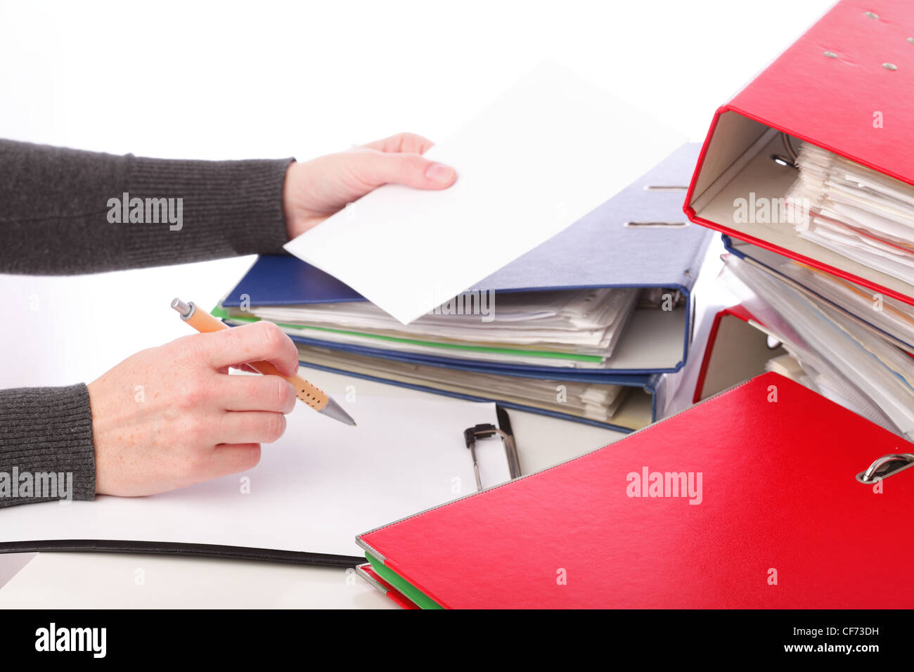 businesswoman - woman hand pen. Pile of folders with old documents and ...