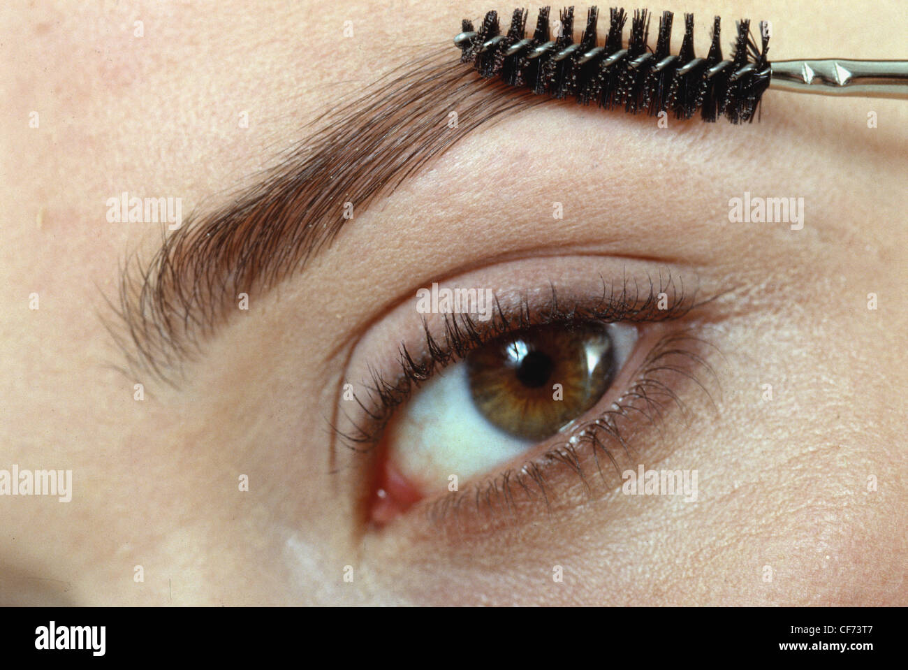 A close up image of female's face, brushing eyebrows Stock Photo - Alamy