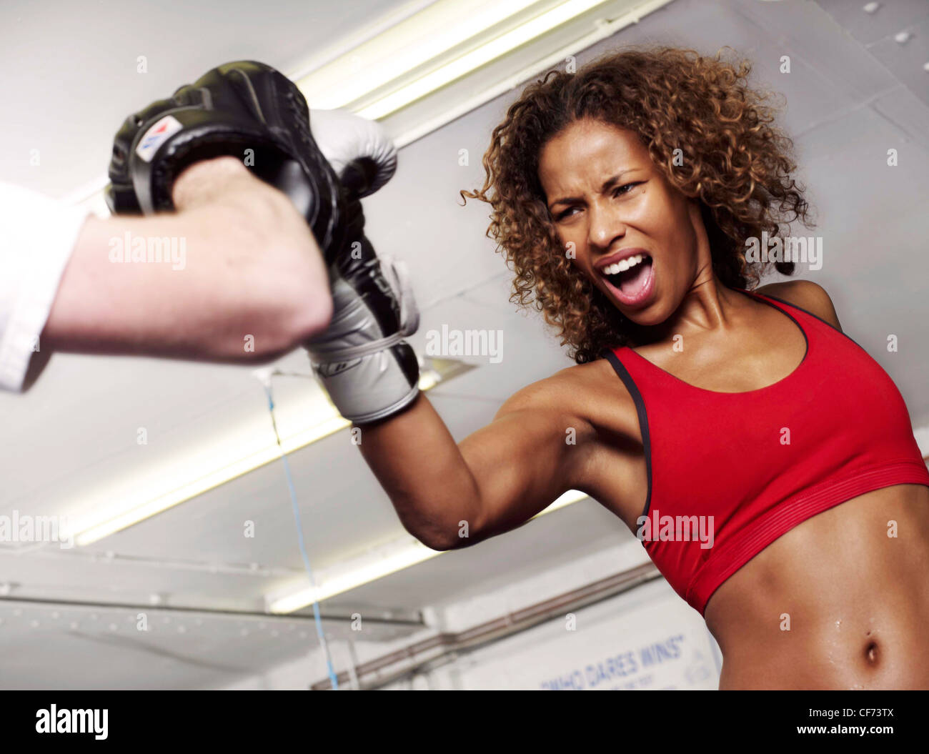 Female with brunette hair, wearing red bra top, boxing at the gym Stock ...