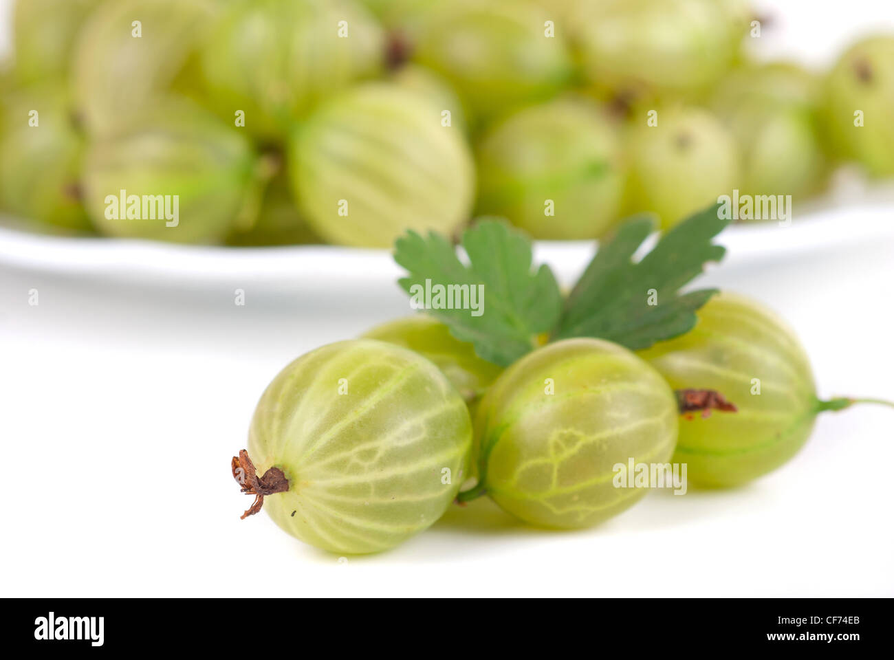 green ripe gooseberries isolated on a white background Stock Photo - Alamy