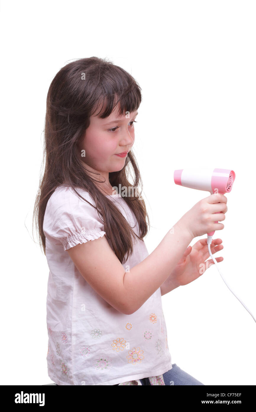 Pretty little girl drying her hair hairdryer isolated on white Stock ...
