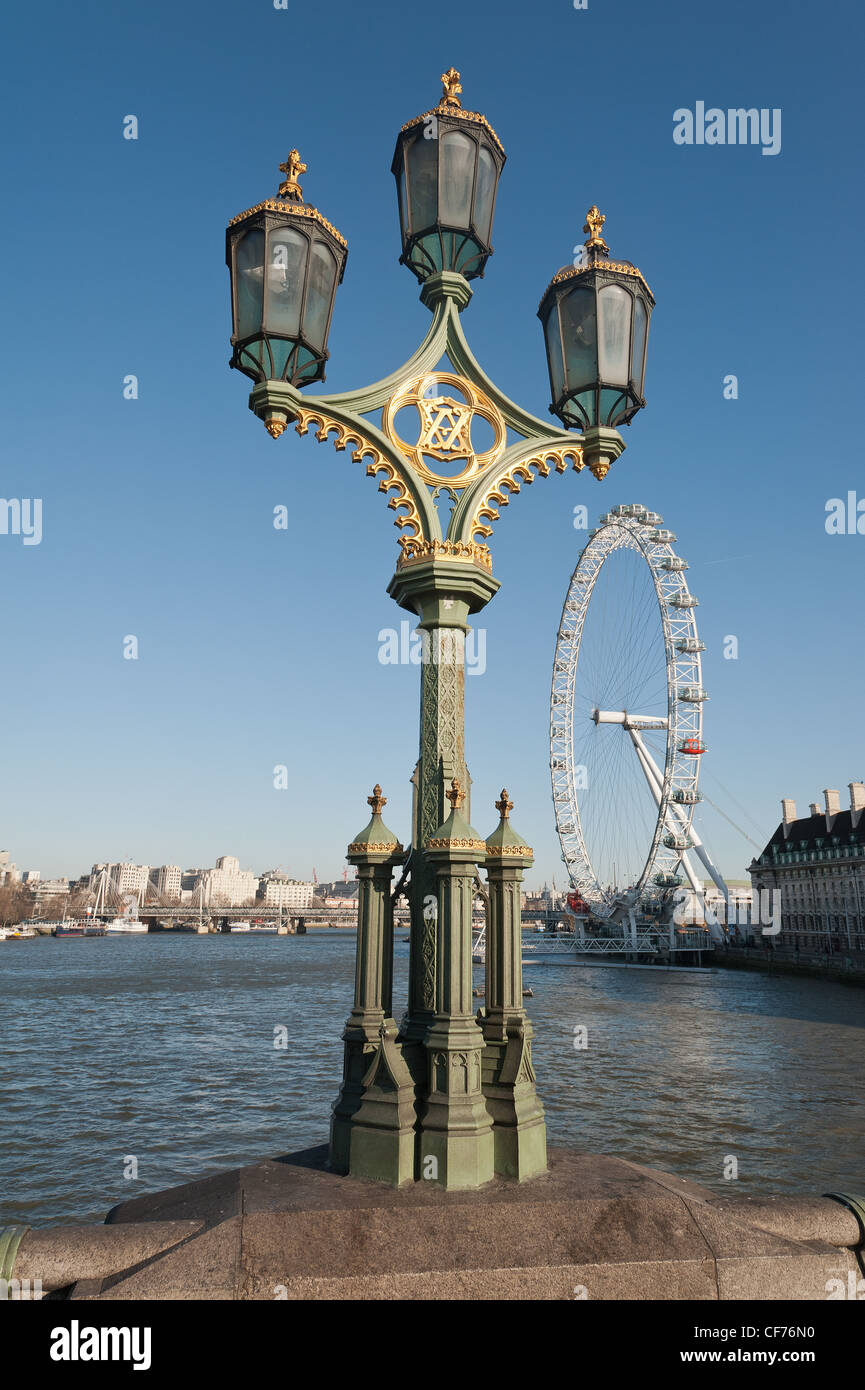 Victorian gas lamp on Westminster bridge contrasts with the London eye ...